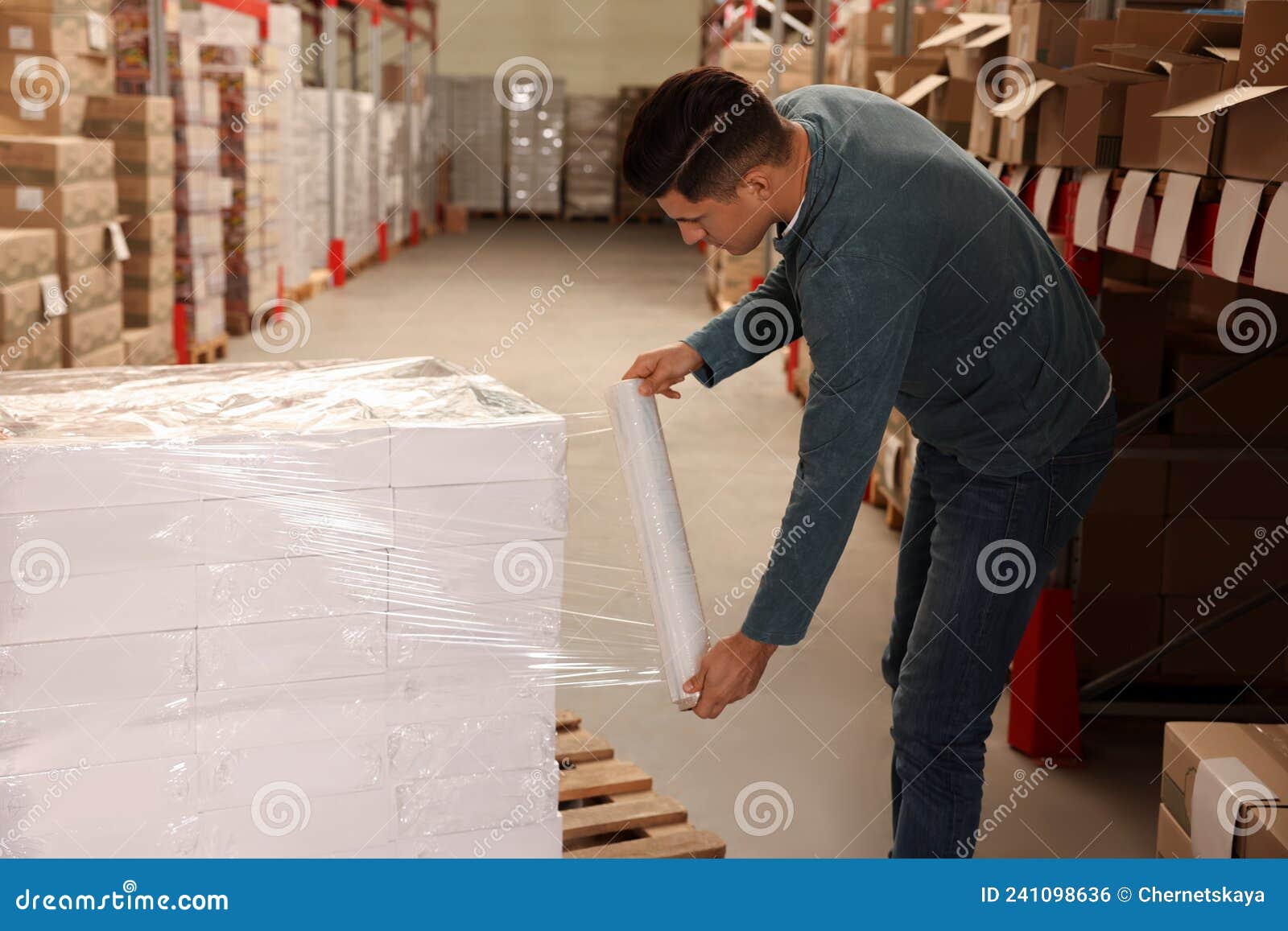 Worker Wrapping Boxes in Stretch Film at Warehouse Stock Photo - Image ...
