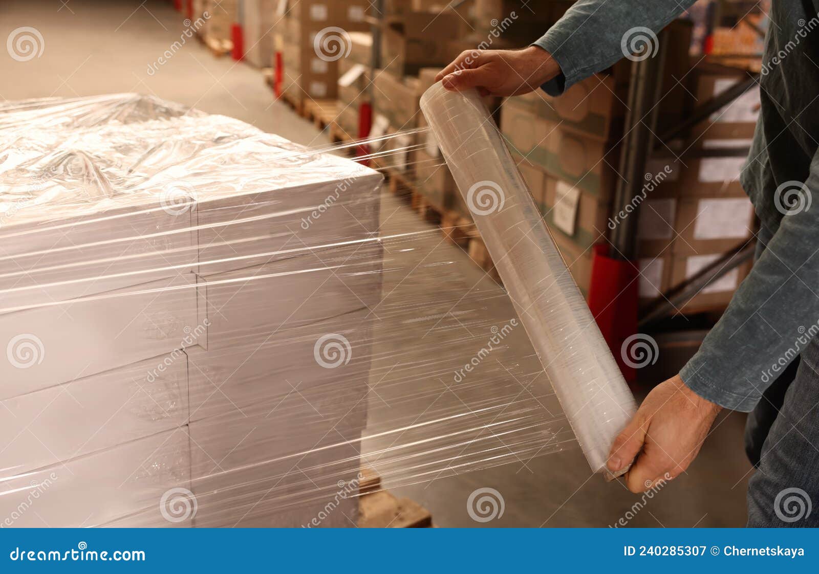 Worker Wrapping Boxes in Stretch Film at Warehouse, Closeup Stock Image ...