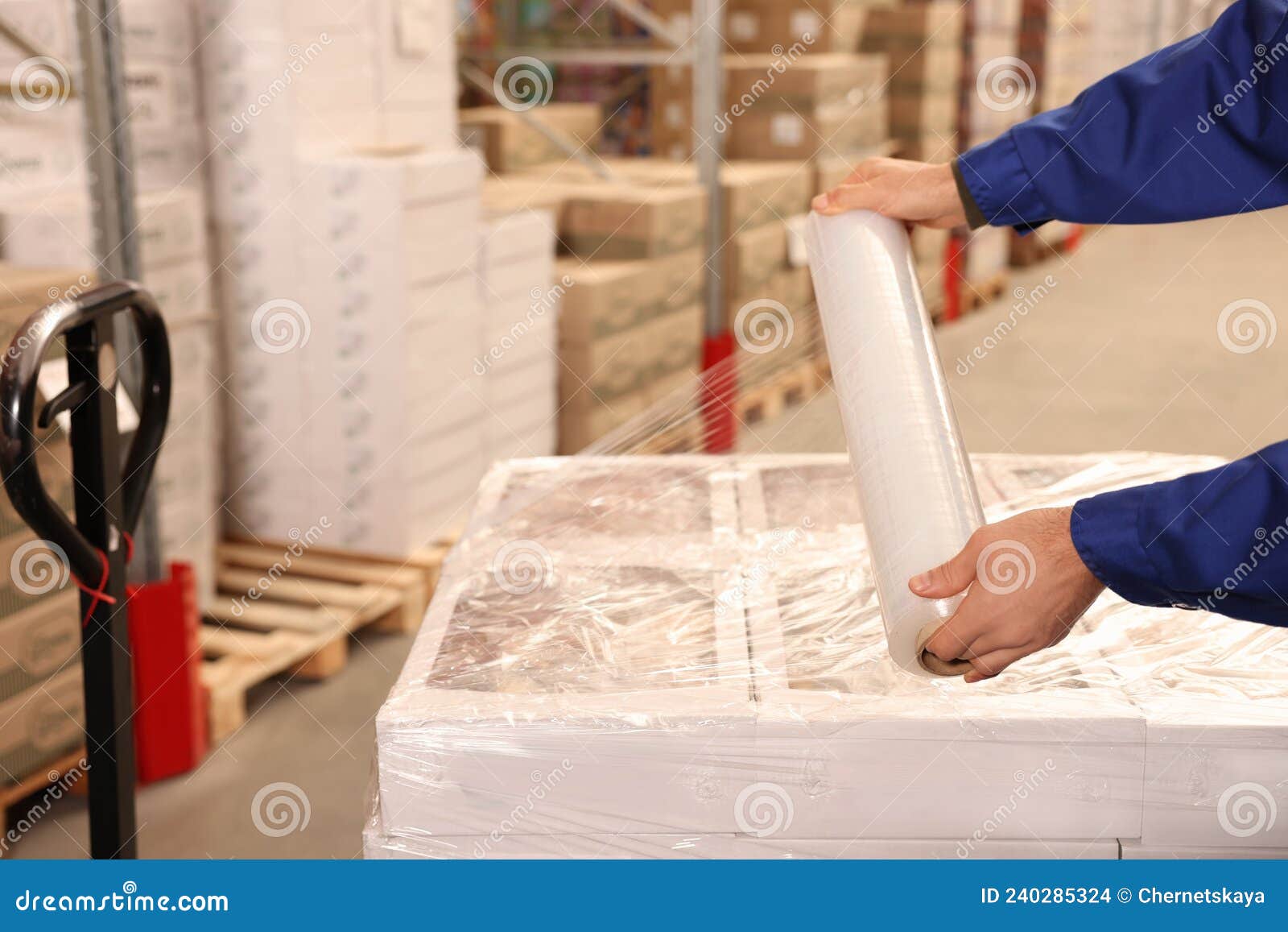 Worker Wrapping Boxes in Stretch Film at Warehouse, Closeup Stock Photo ...