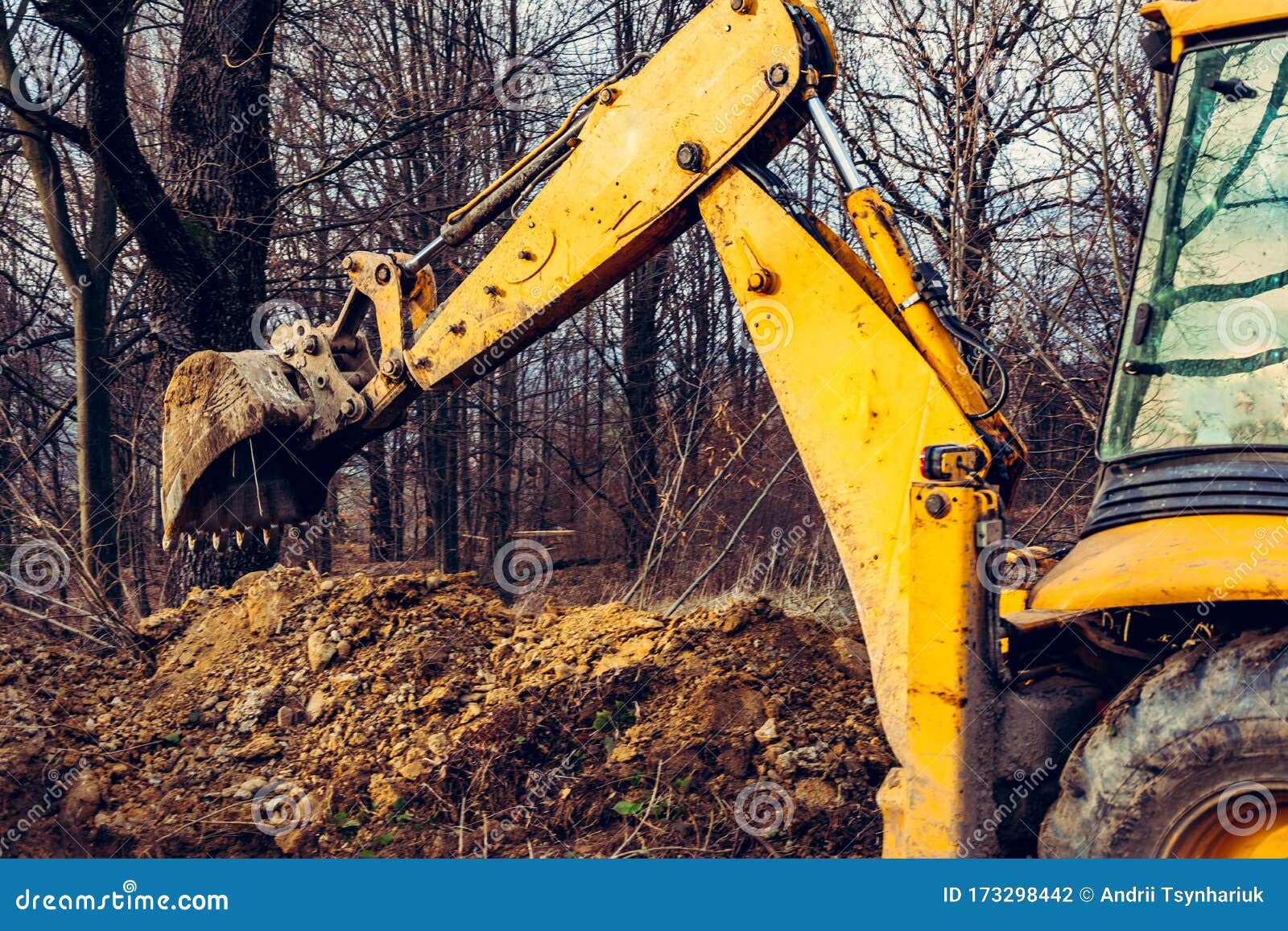 Worker and Yellow Old Excavator in the Forest Dig a Pit for Water ...