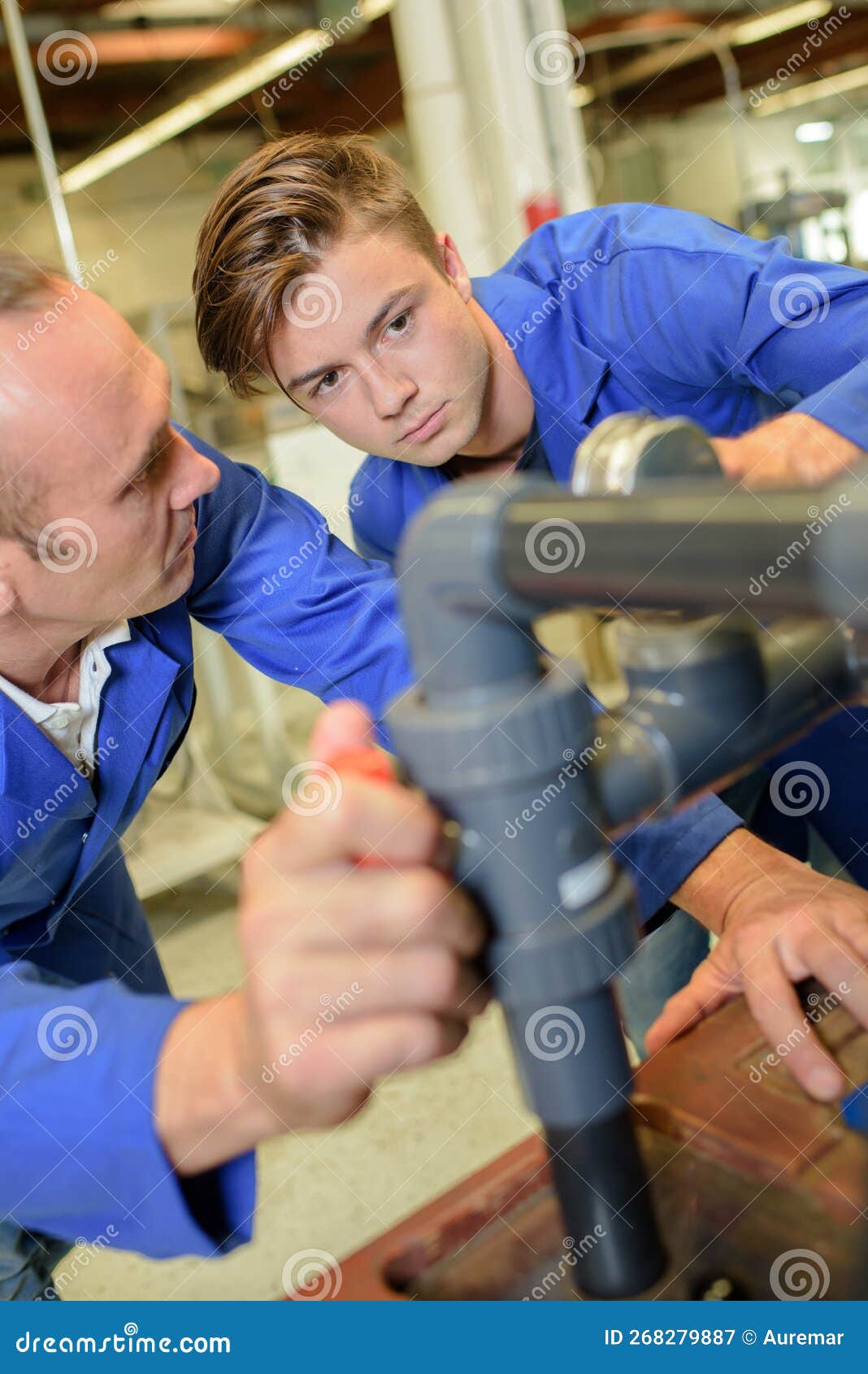 Worker and Young Apprentice Checking Gauge Stock Image - Image of ...
