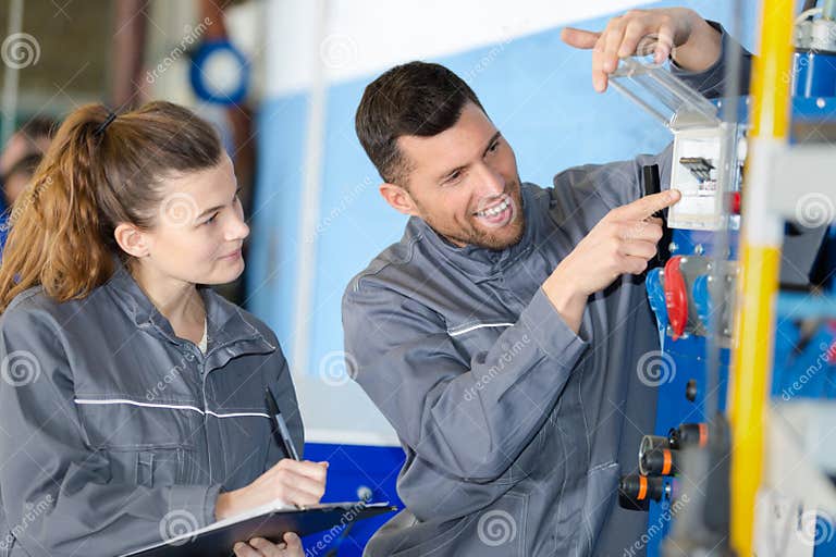Workers Adjusting Dial on Machine Stock Image - Image of maintenance ...