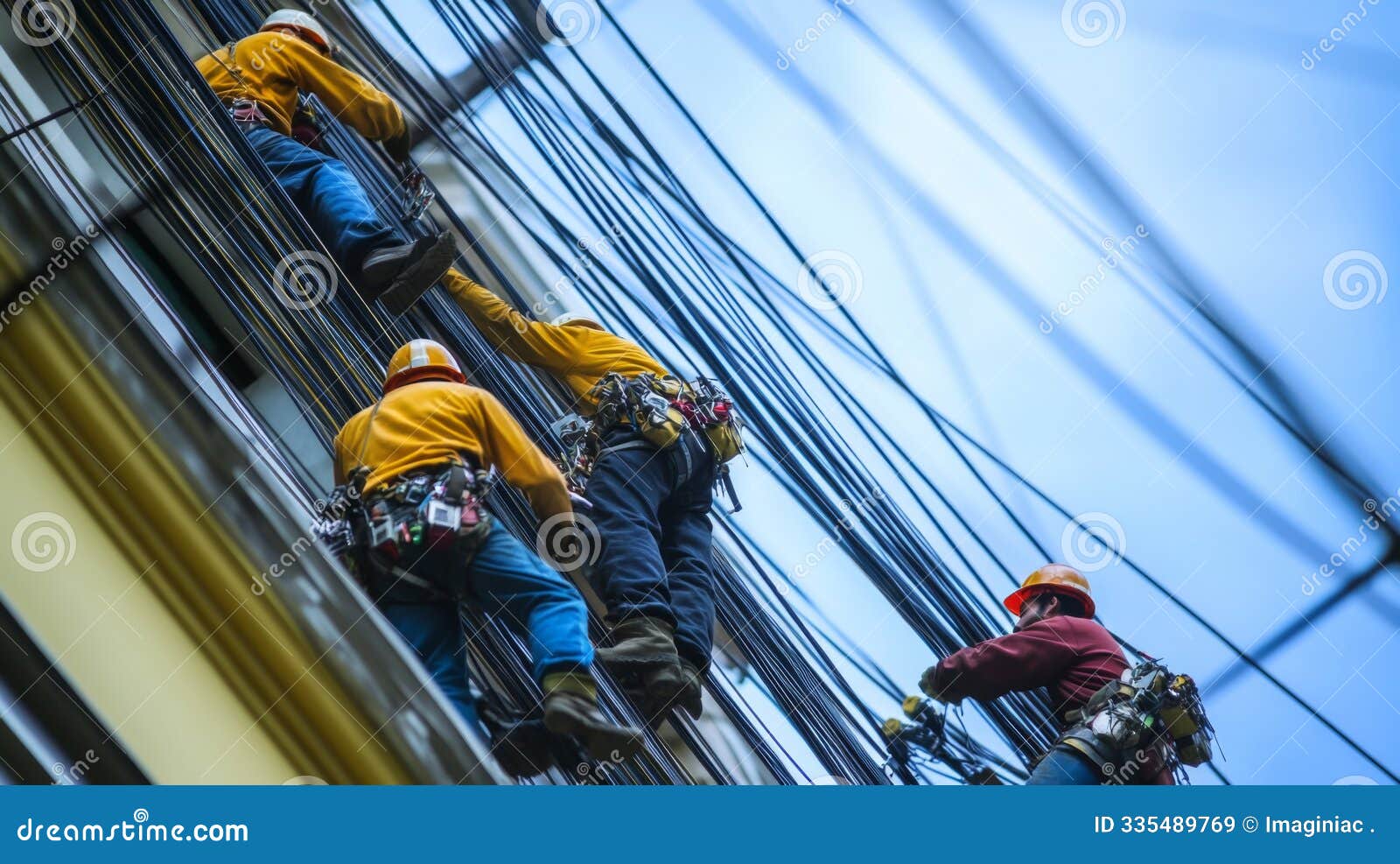 Workers Ascending Building with Cables and Safety Gear Stock ...
