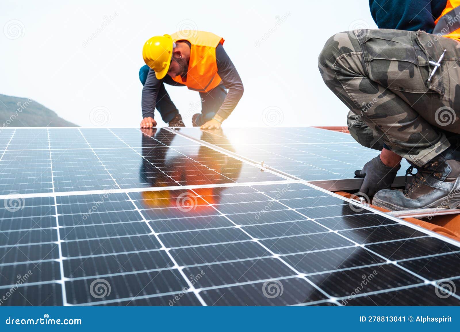 Workers Assemble Energy System with Solar Panel for Electricity and Hot ...