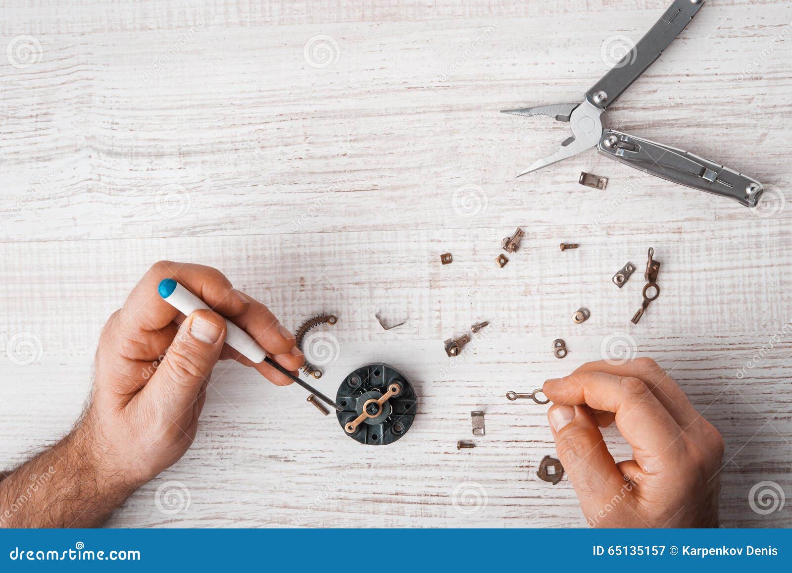 Workers Assemble a Mechanism with a Screwdriver and Pliers Stock Image ...