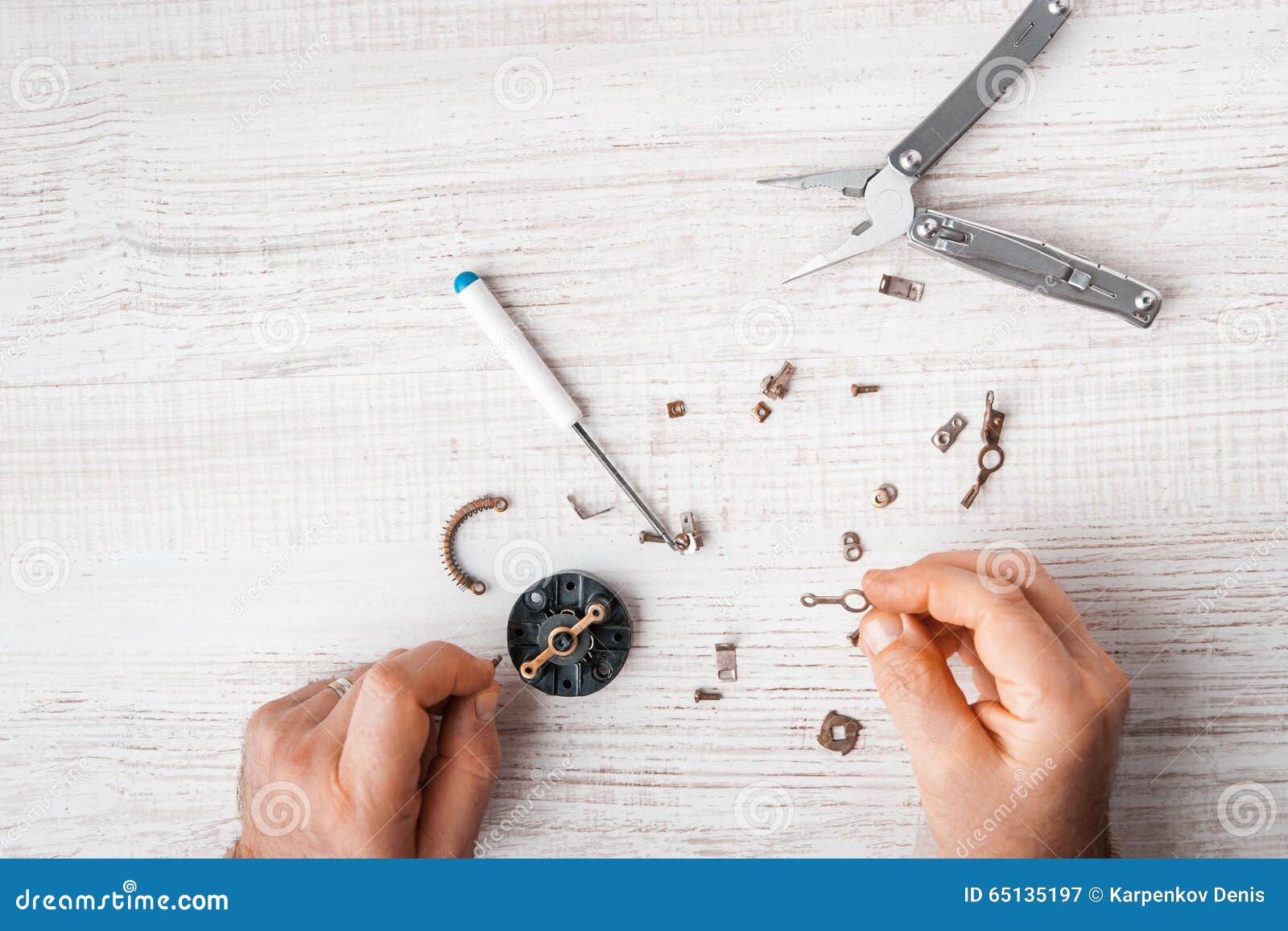 Workers Assemble a Mechanism with a Screwdriver and Pliers Stock Image ...