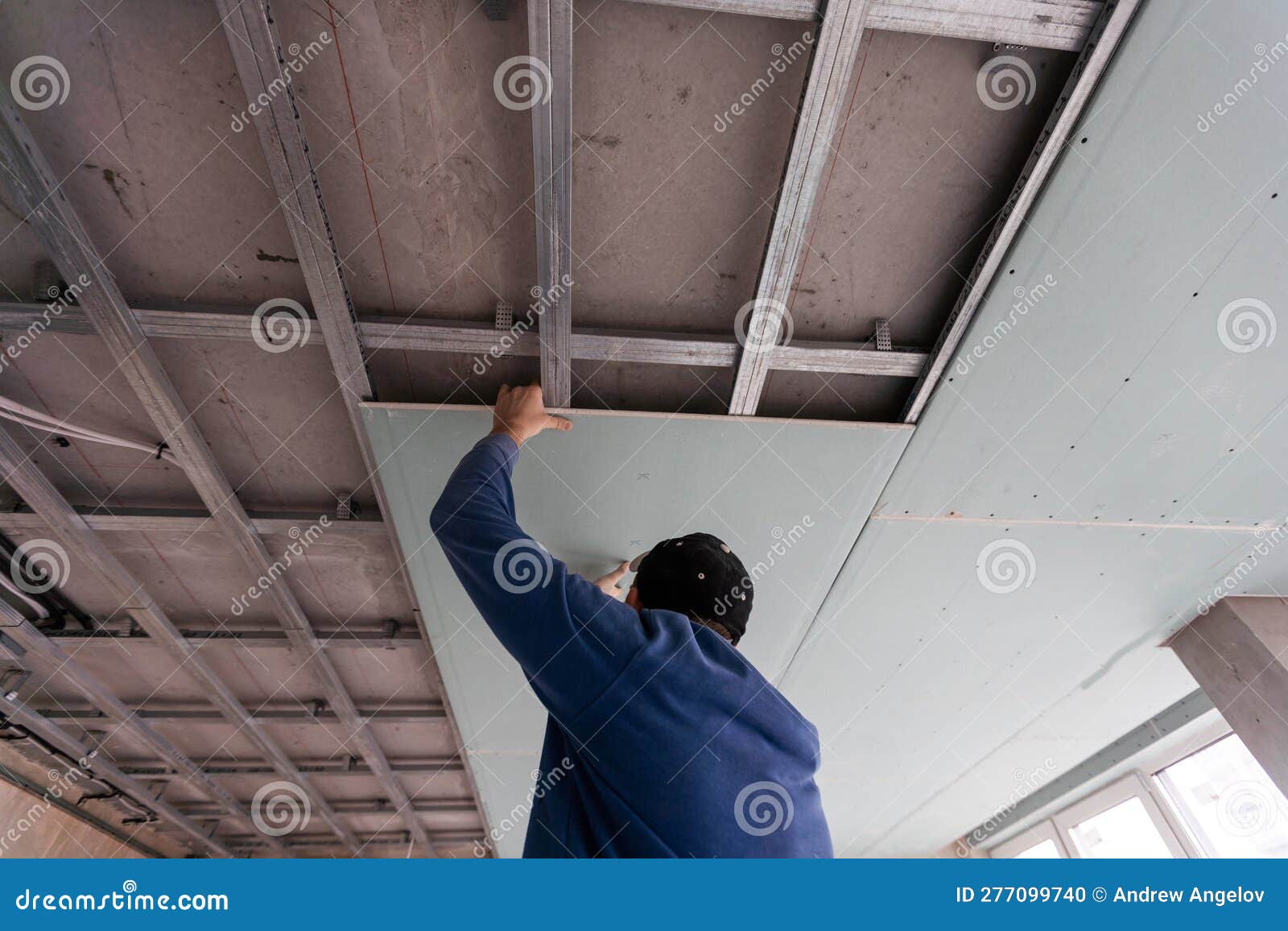 Workers Assemble a Suspended Ceiling with Drywall Stock Photo - Image ...