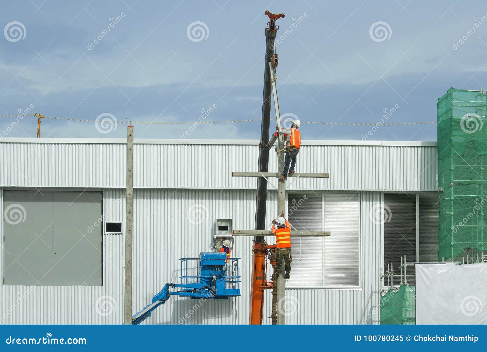 Workers in a Baskets are Installing Building a Factory and Red C ...