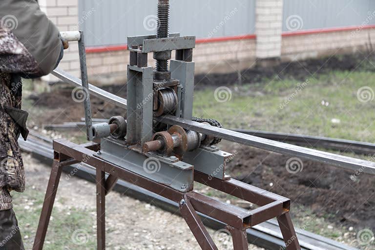 Workers Bend Metal in a Pipe Bender. Stock Photo - Image of building ...
