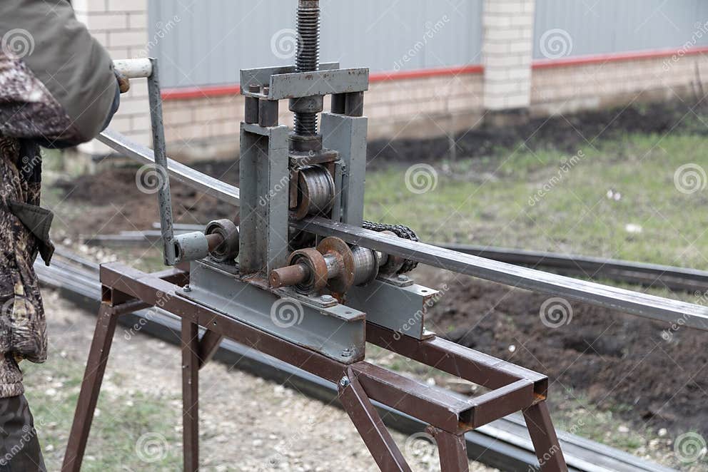 Workers Bend Metal in a Pipe Bender. Stock Photo - Image of building ...