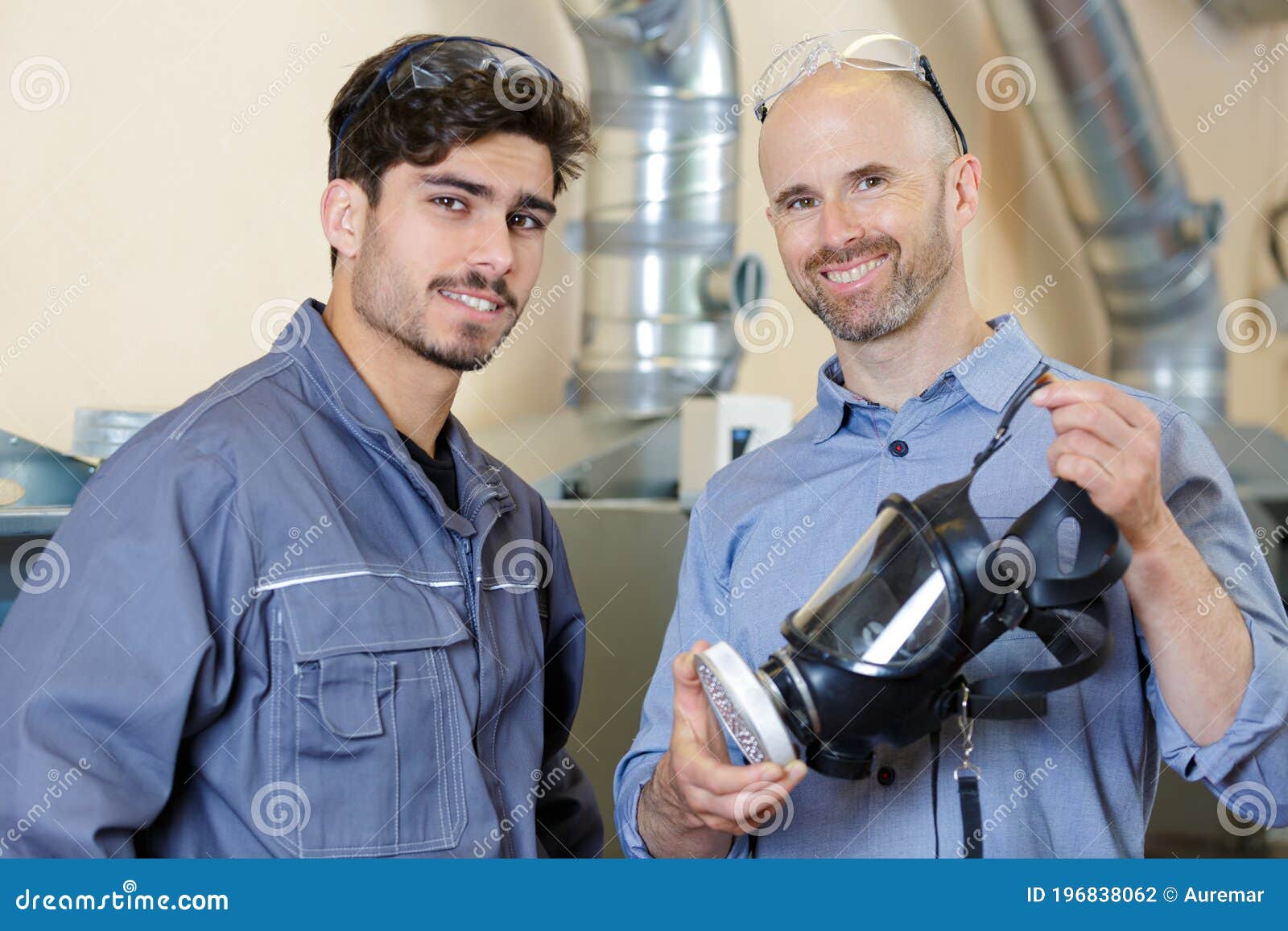 Workers in blue work suit stock photo. Image of helmet - 196838062