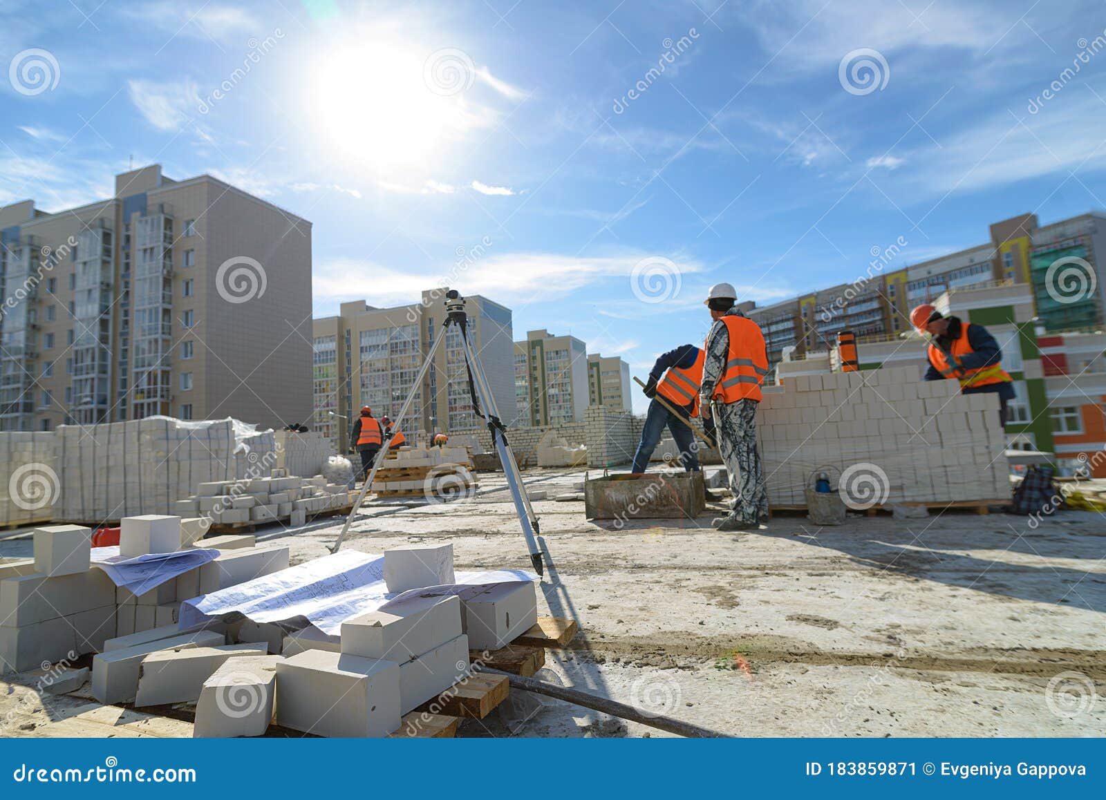 Workers Build a Brick Wall on a Construction Site. in the Foreground is ...