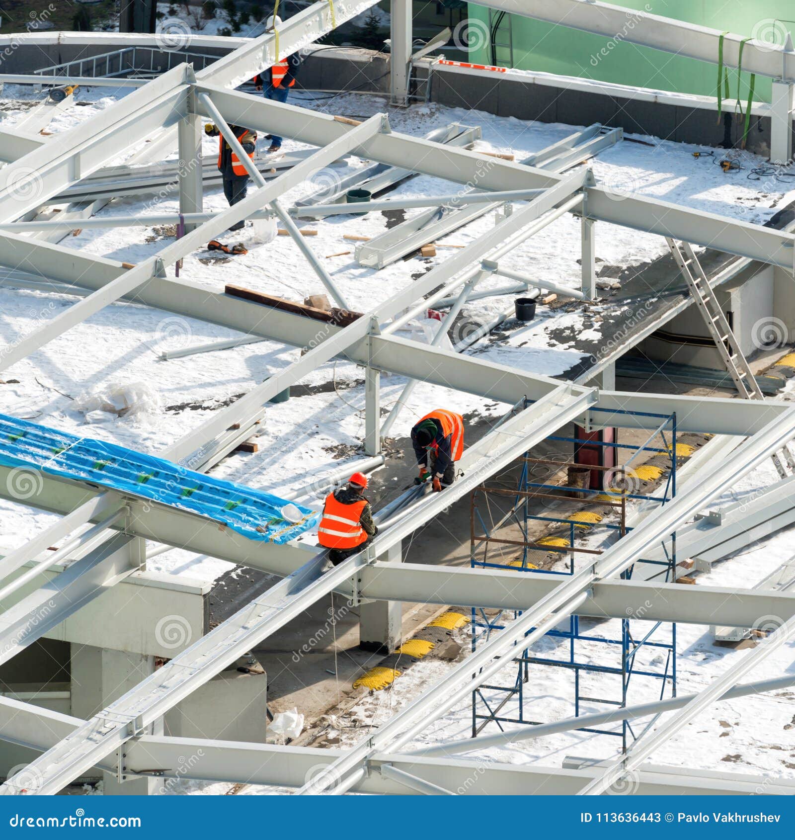 Building Roof Construction Insulation Works. Worker With Yellow Vest At ...
