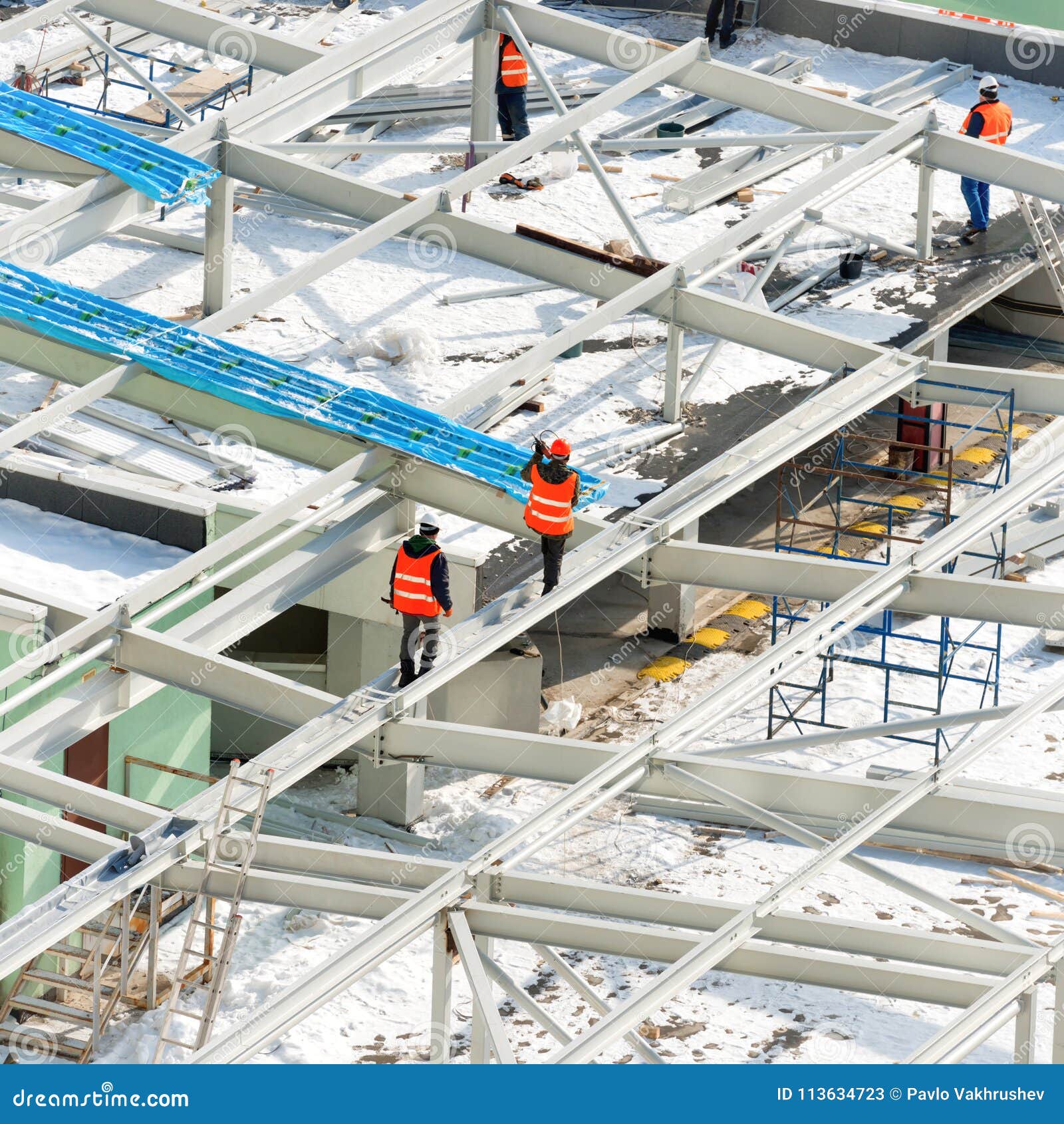 Building Roof Construction Insulation Works. Worker With Yellow Vest At ...