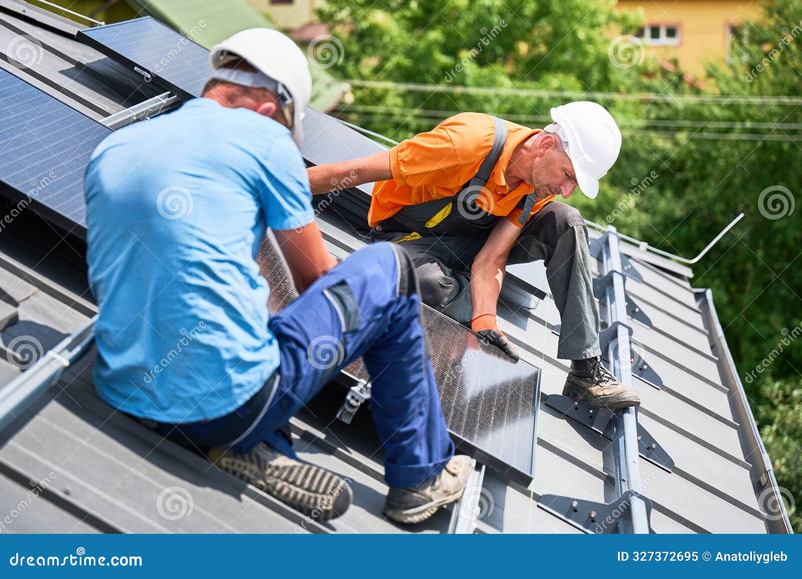 Workers Building Solar Panel System on Roof of House. Men Installing ...