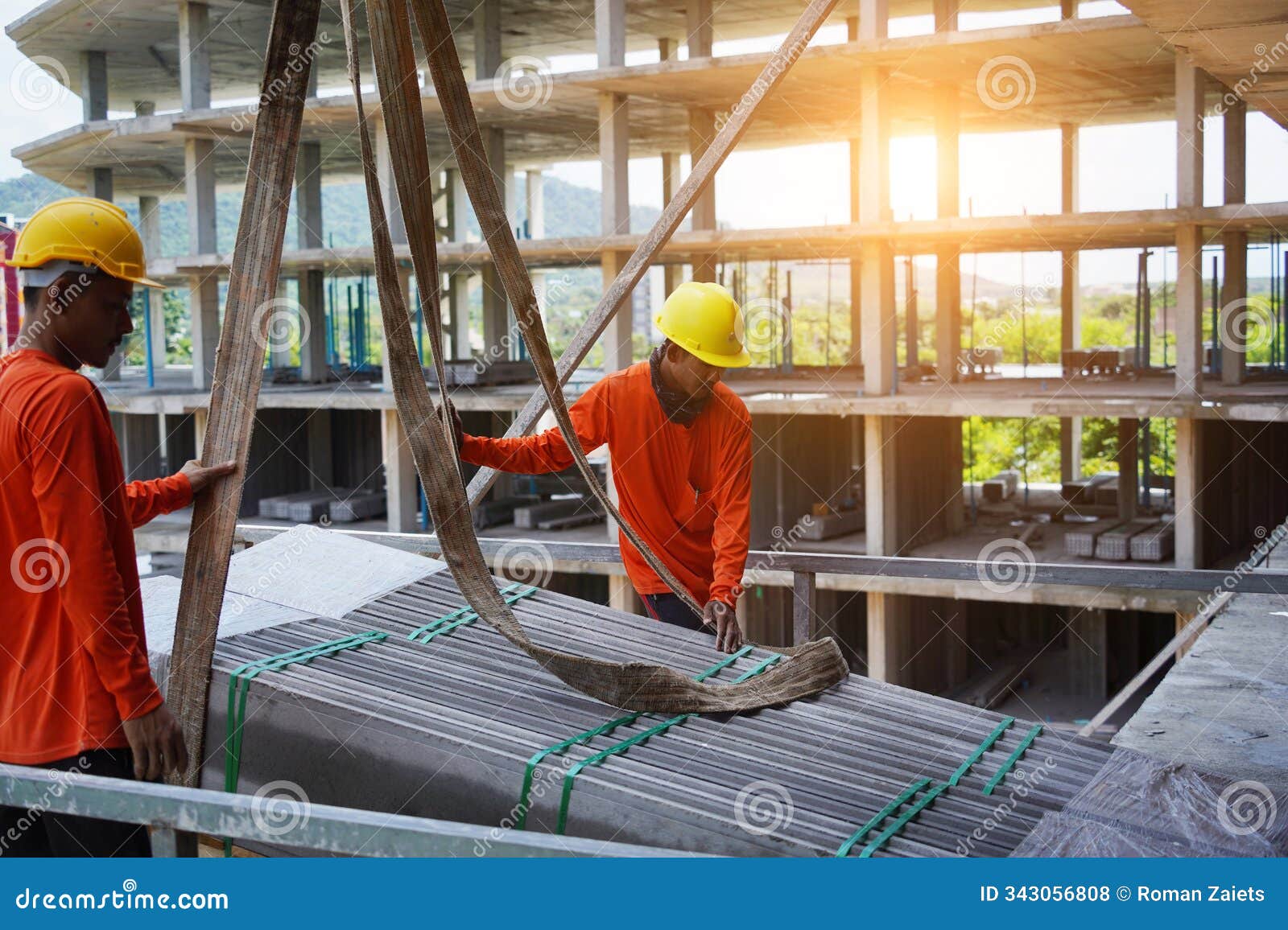 Workers at a Building Under Construction Take Slabs from a Crane Stock ...