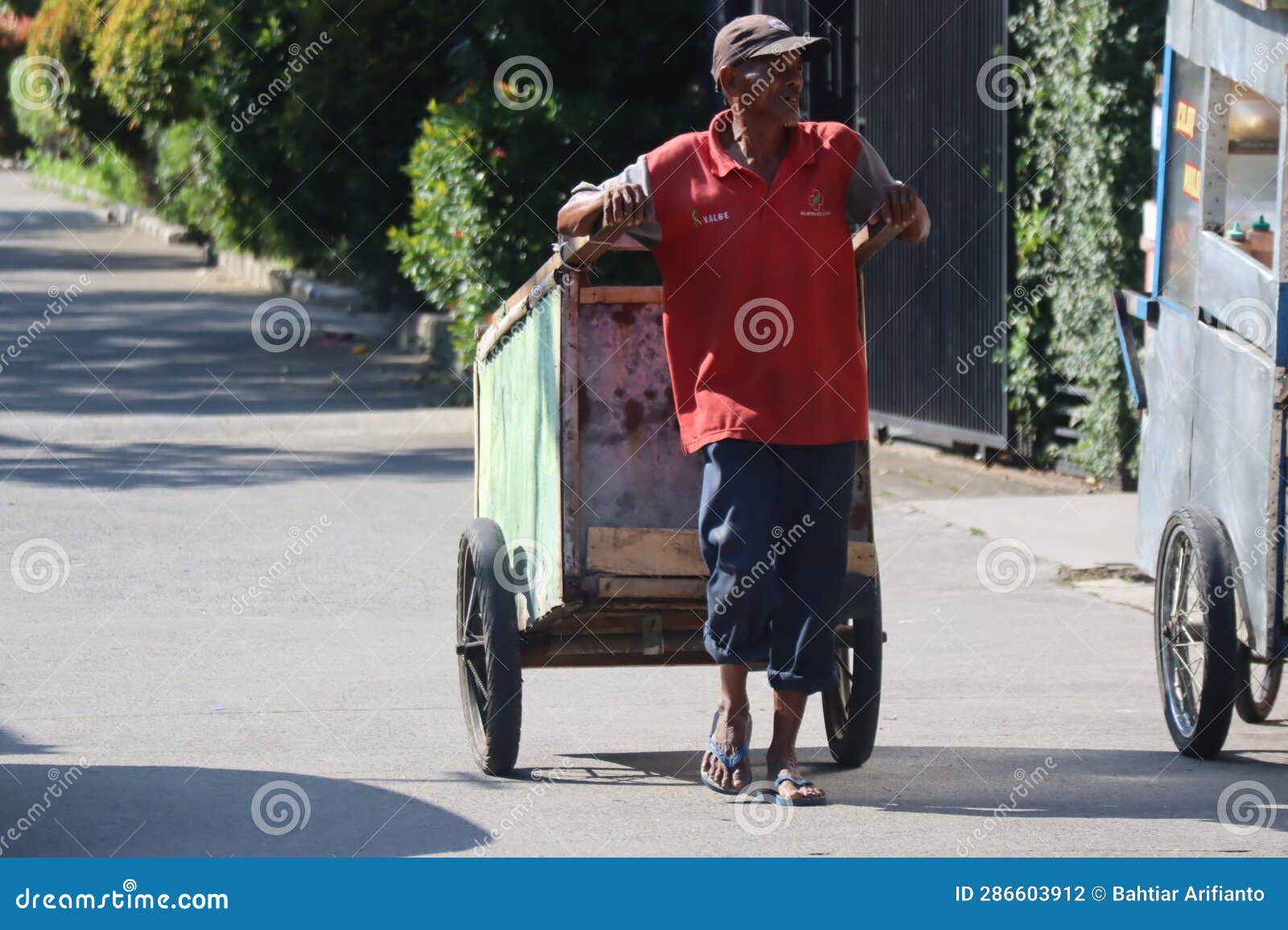 Workers Carry Carts on the Side of the Main Road during the Day ...