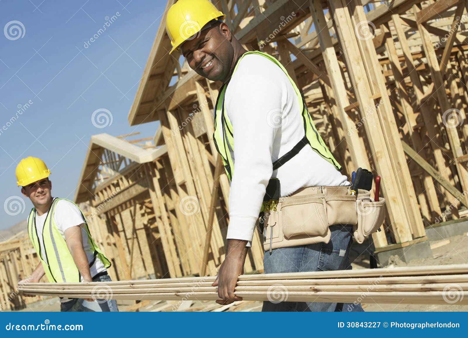 Workers Carrying Boards at Construction Site Stock Image - Image of ...