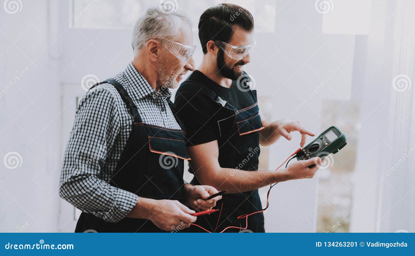 Workers Checking Device in Hands in Repair Shop Stock Image - Image of ...