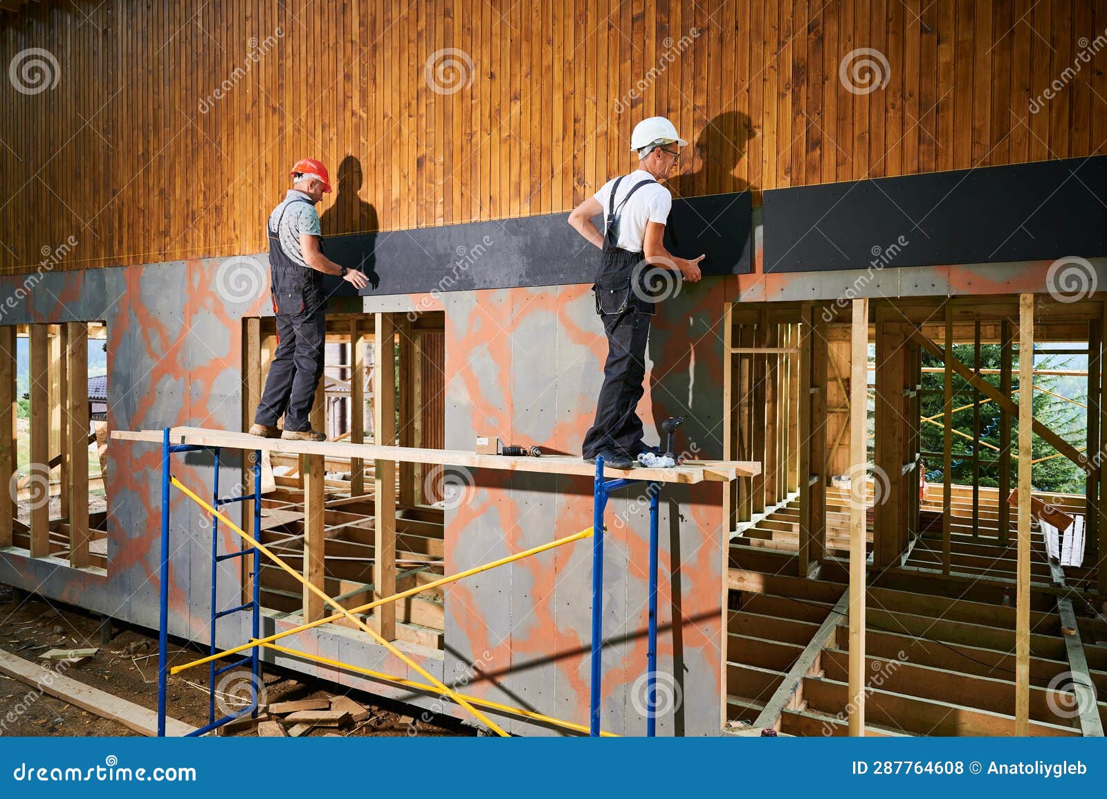 Workers Cladding Facade of House with Cement Particle Boards while ...