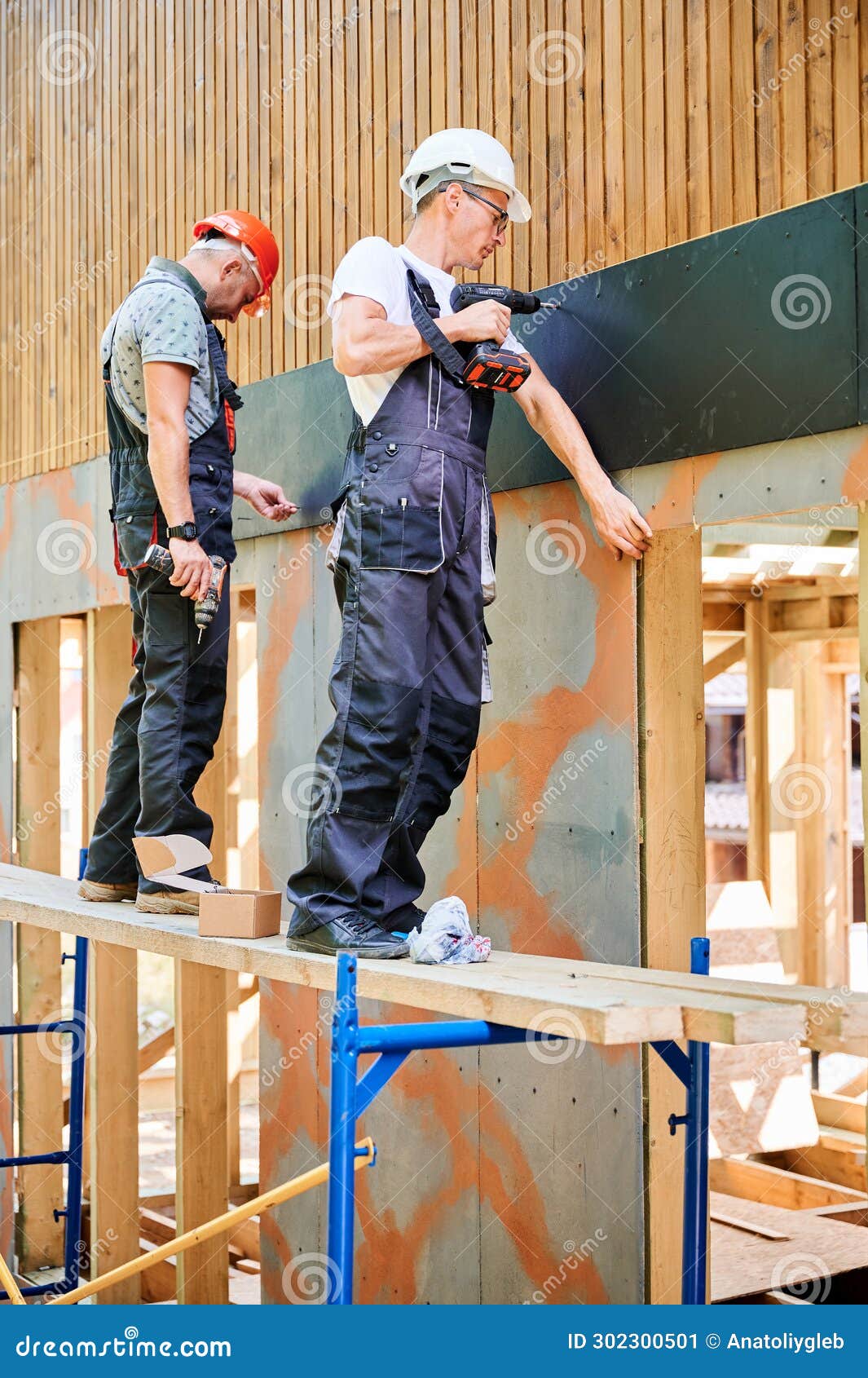 Workers Cladding Facade of House with Cement Particle Boards while ...