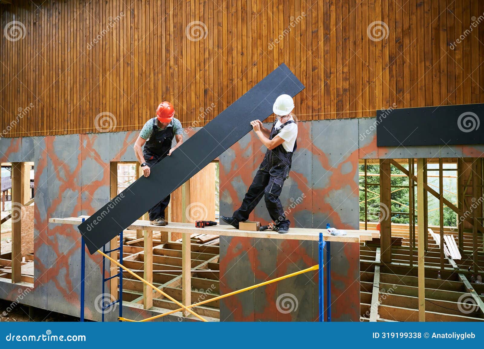 Workers Cladding Facade Of House With Cement Particle Boards While ...