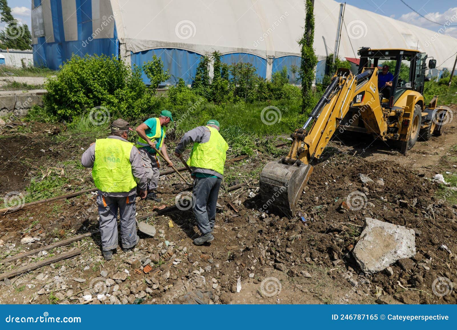 Workers Clean an Area from Vegetation and Railroad Debris for Future ...