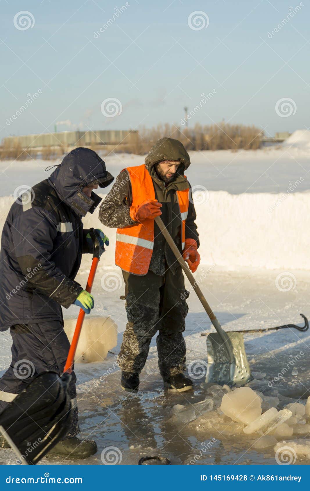 Two Workers in Overalls Remove Ice from the Hole Stock Photo - Image of ...