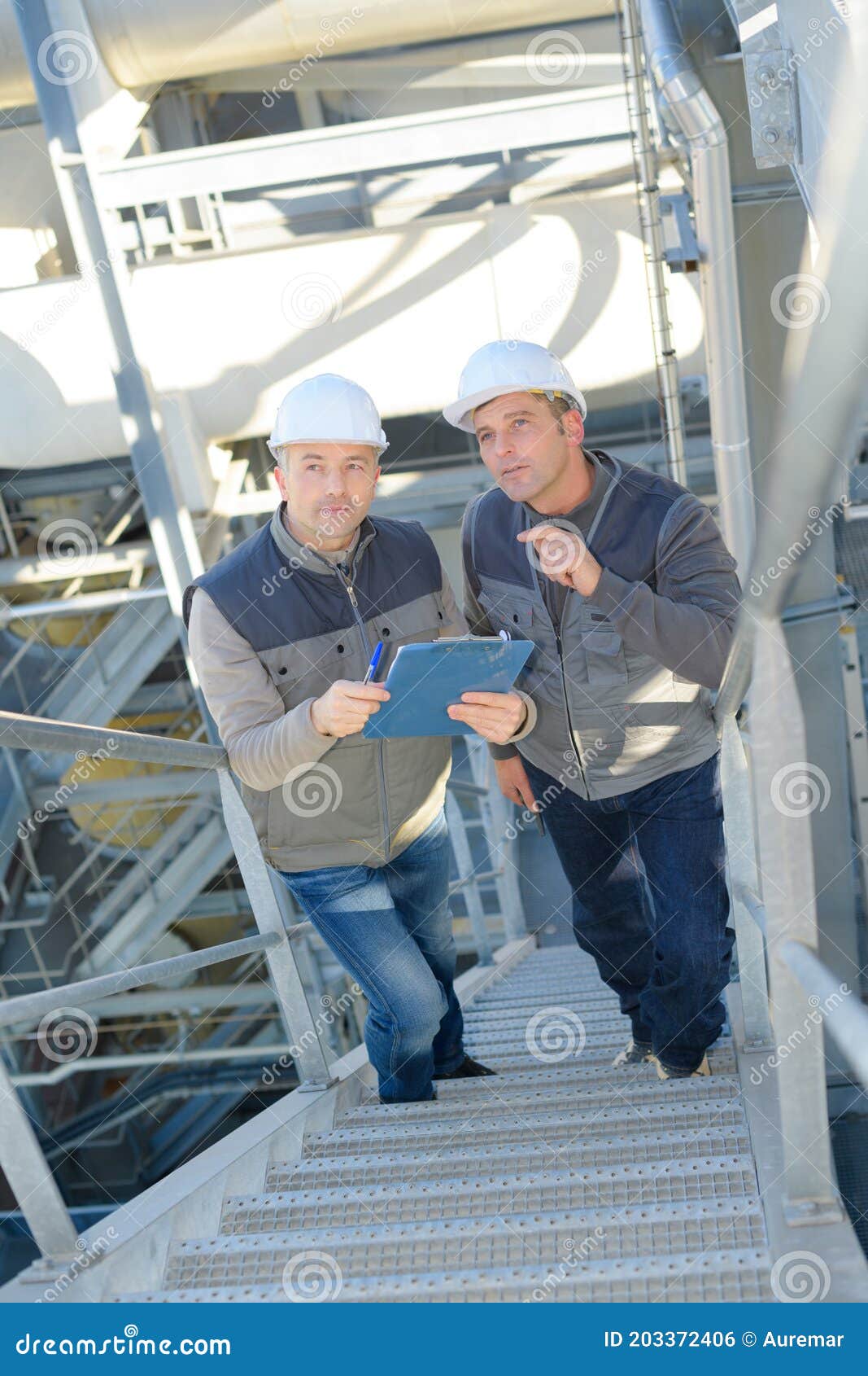 Workers Climbing Stairway on Industrial Worksite Stock Photo - Image of ...