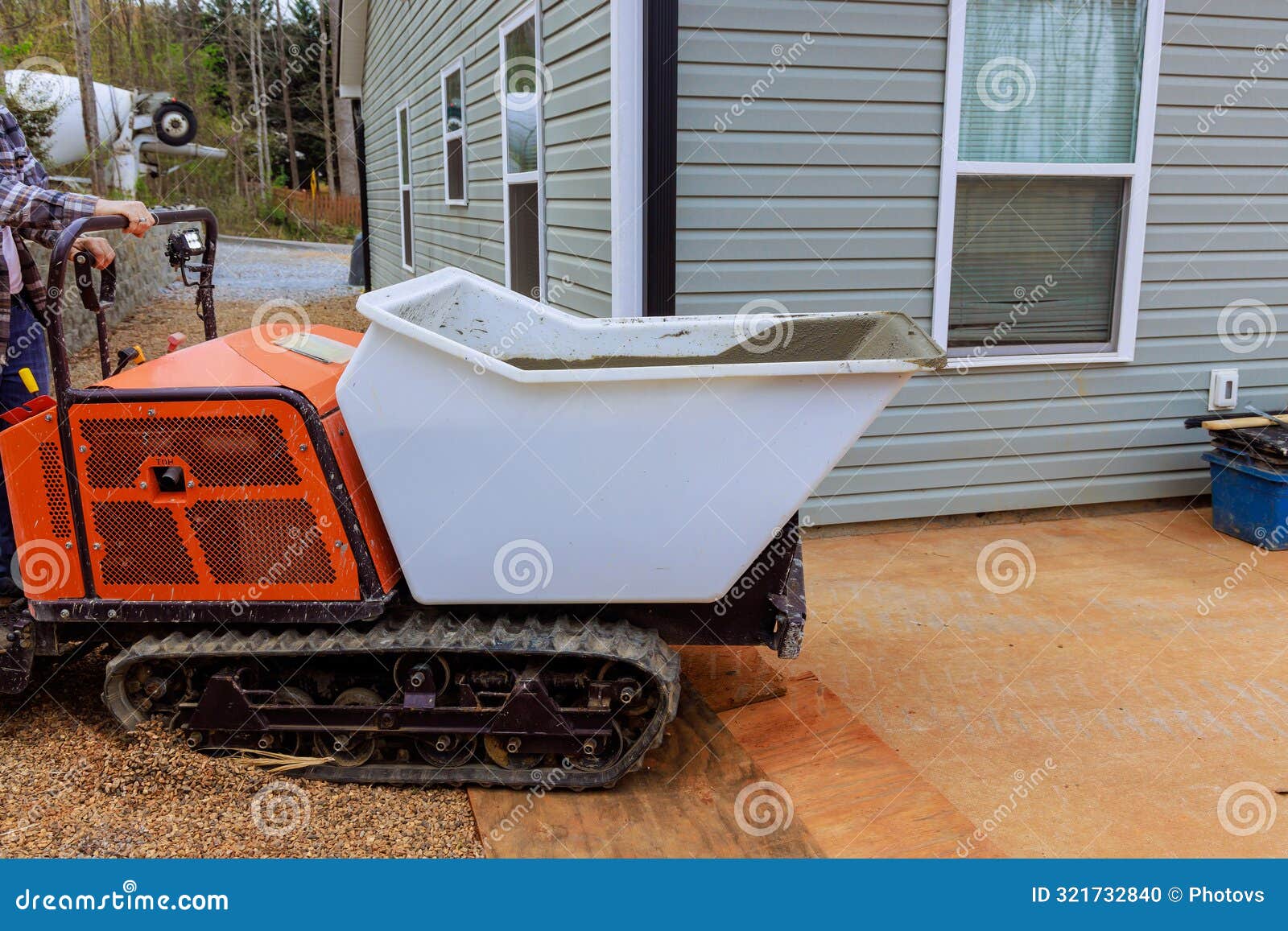Workers in Construction Industry Use Wheelbarrow with a Dumper Track ...