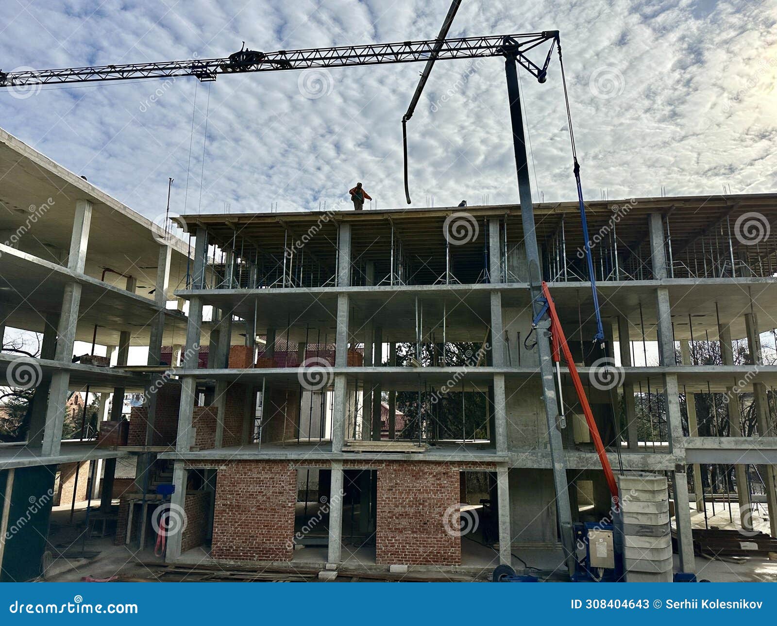 Workers at a Construction Site Against the Backdrop of the Construction ...