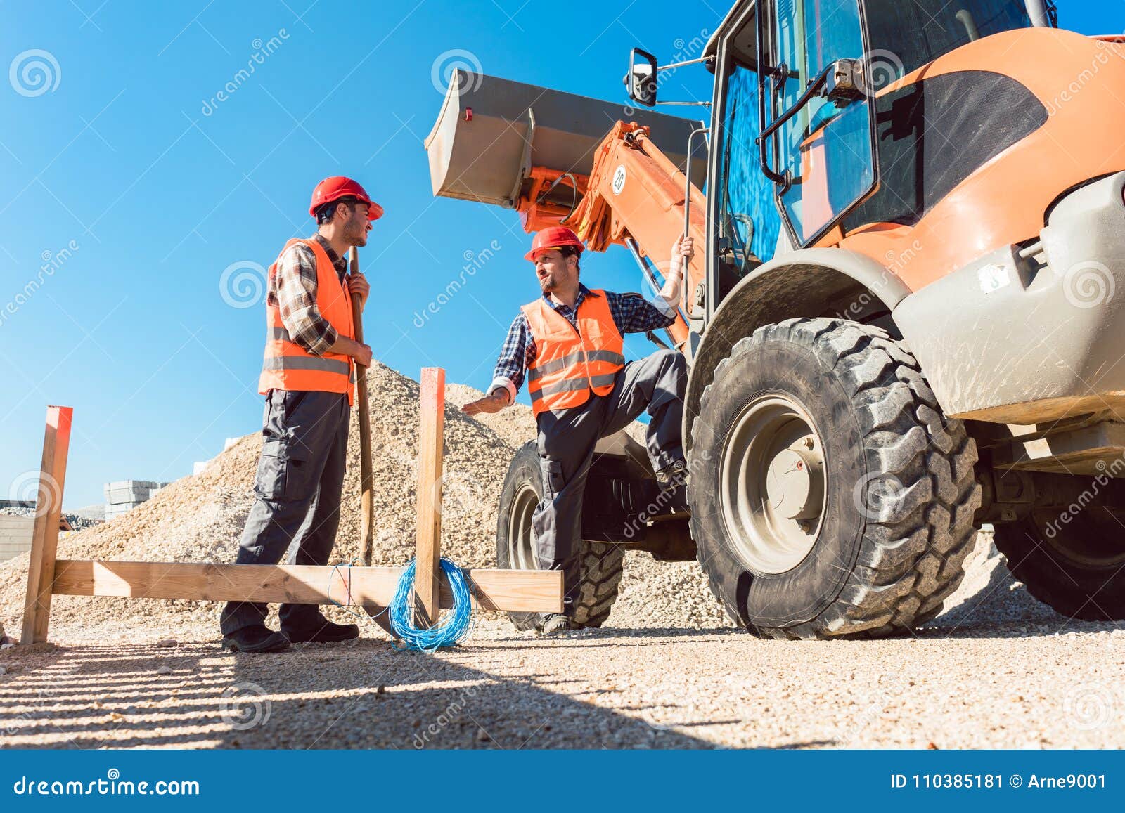 Workers on Construction Site Discussing the Use of Tools Stock Image ...