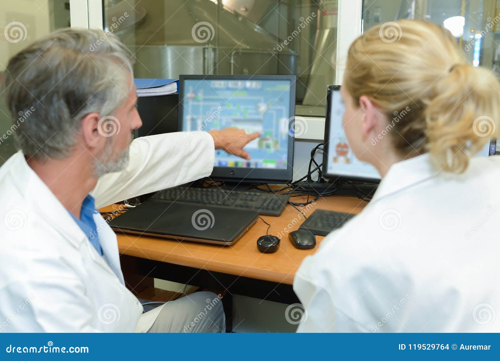 Workers Discussing Data on Computer Screen Stock Photo - Image of ...