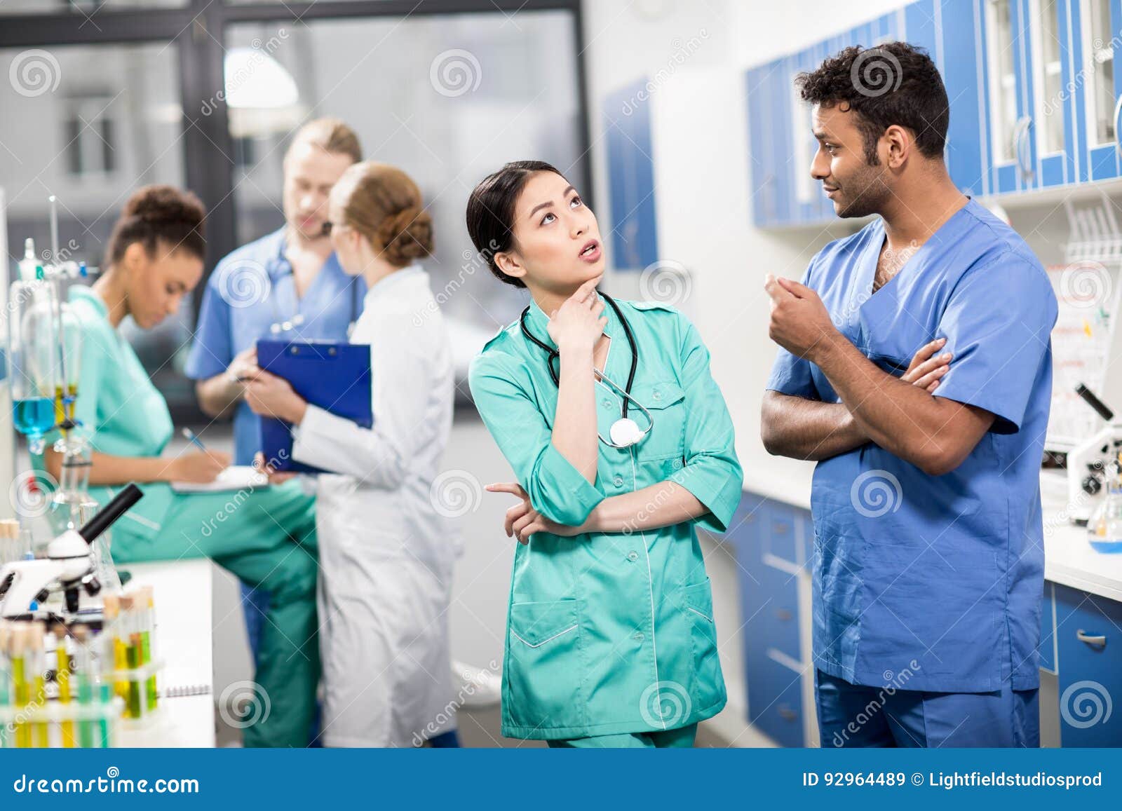 Workers Discussing Work with Colleagues Behind in Laboratory Stock ...