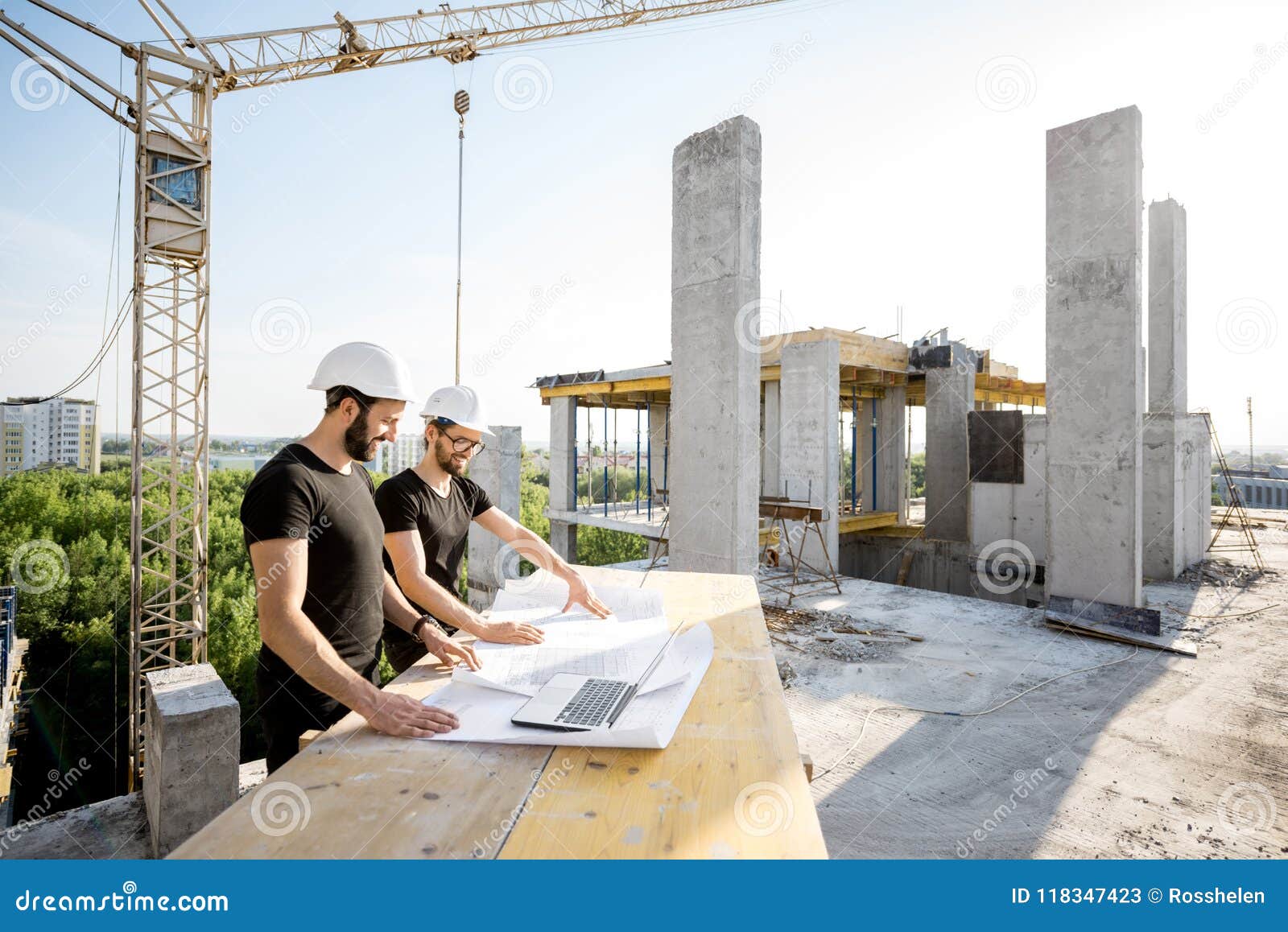Workers with Drawings at the Construction Site Stock Image - Image of ...