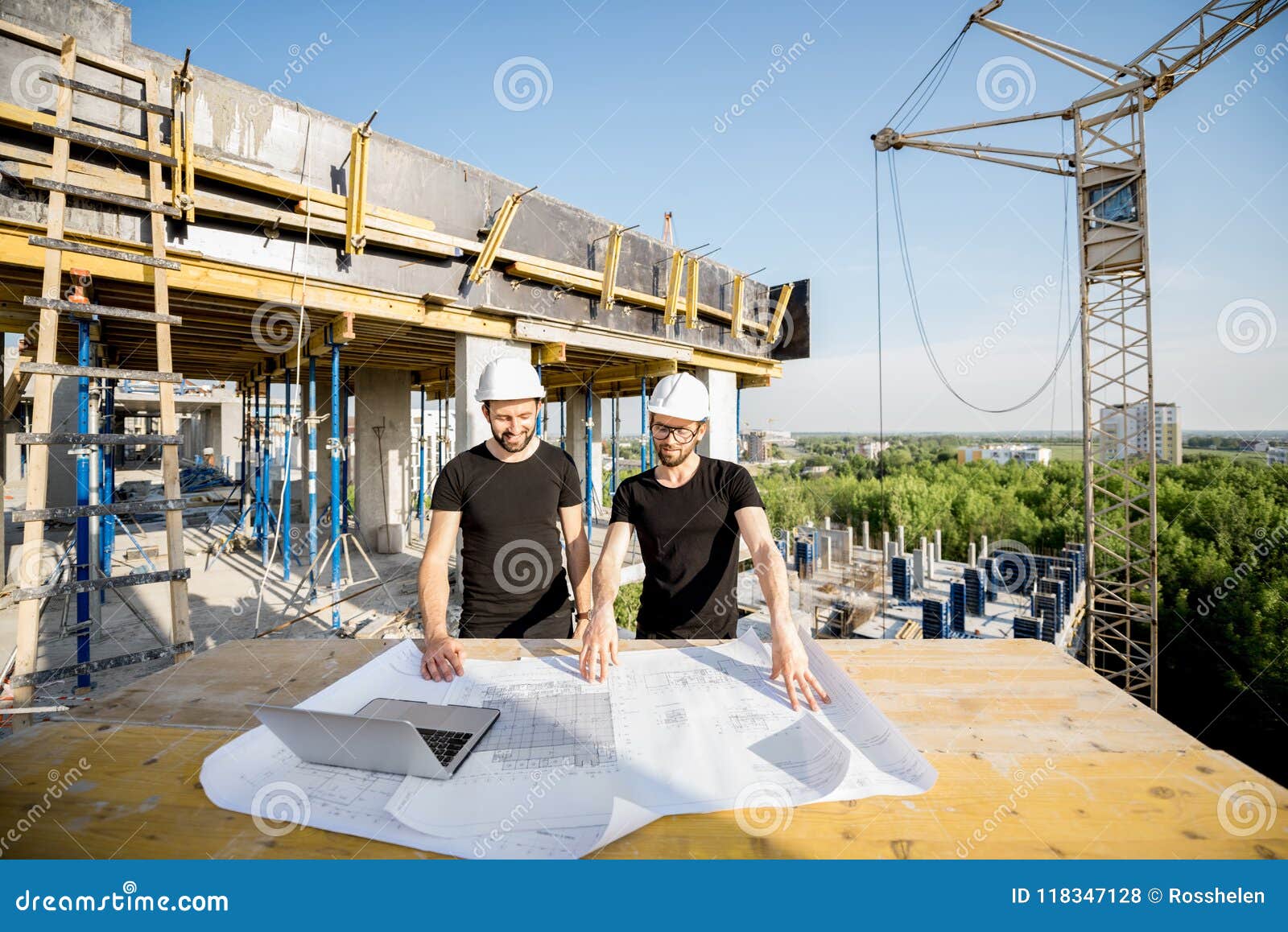 Workers with Drawings at the Construction Site Stock Photo - Image of ...