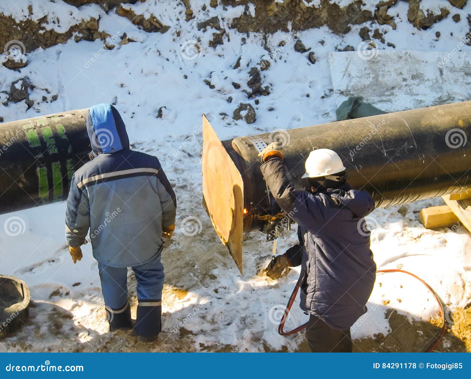 The Workers Engaged in the Construction of the Pipeline. Welders Build ...