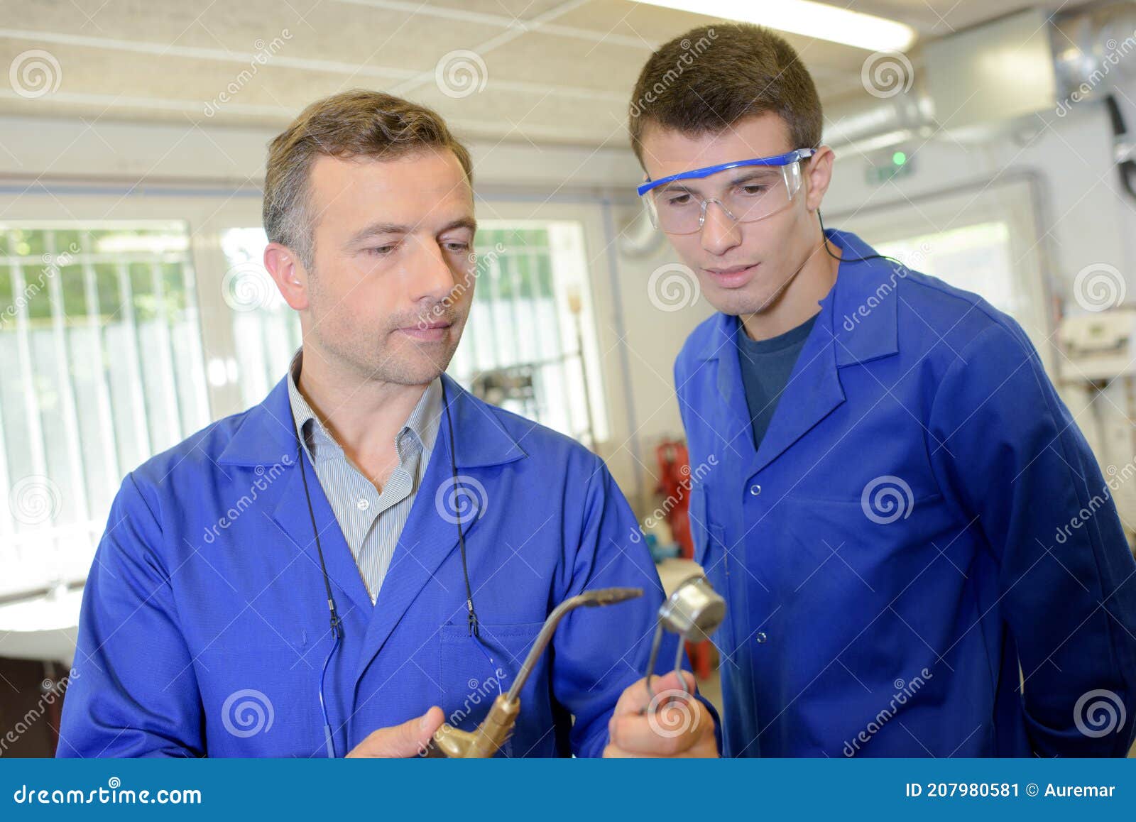Workers and Factory Apprentice in Factory - Soldering Lesson Stock ...