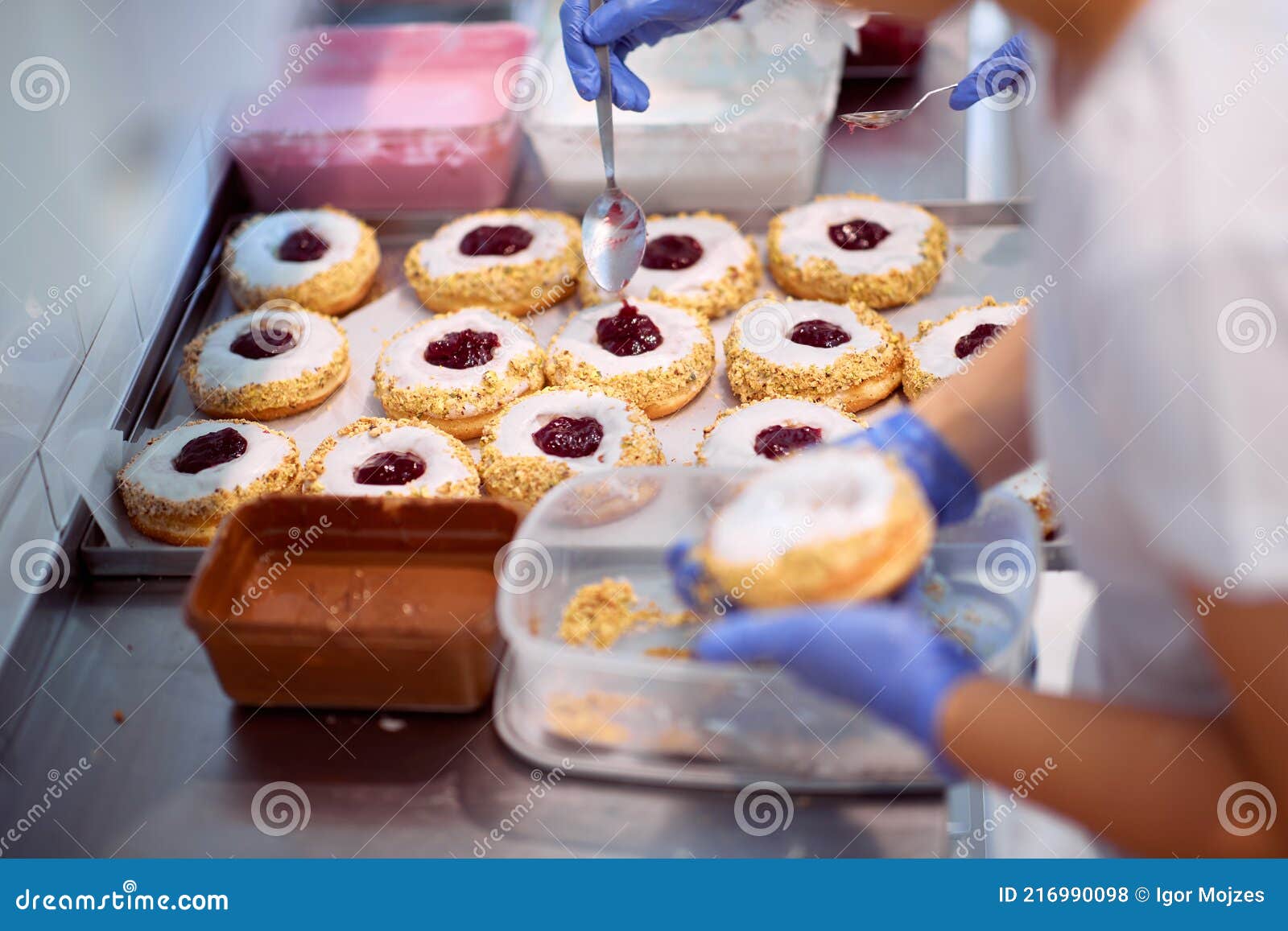 Workers Fill Delicious Donuts with Jam in a Candy Workshop. Pastry ...