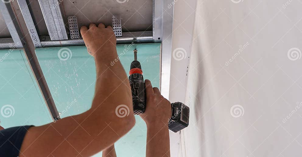Workers Fitting Panel into Frame of Ceiling. Stock Photo - Image of ...