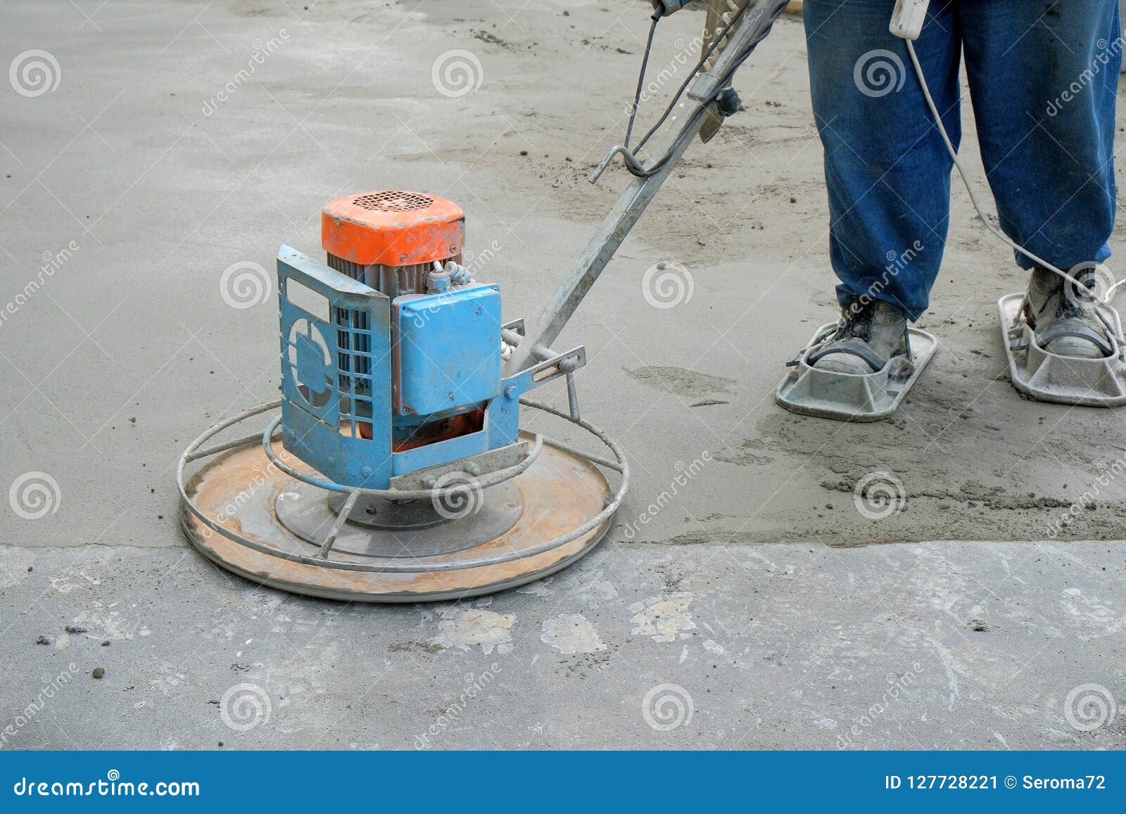 The Workers Grind the Concrete Floor at the Construction Site Stock ...