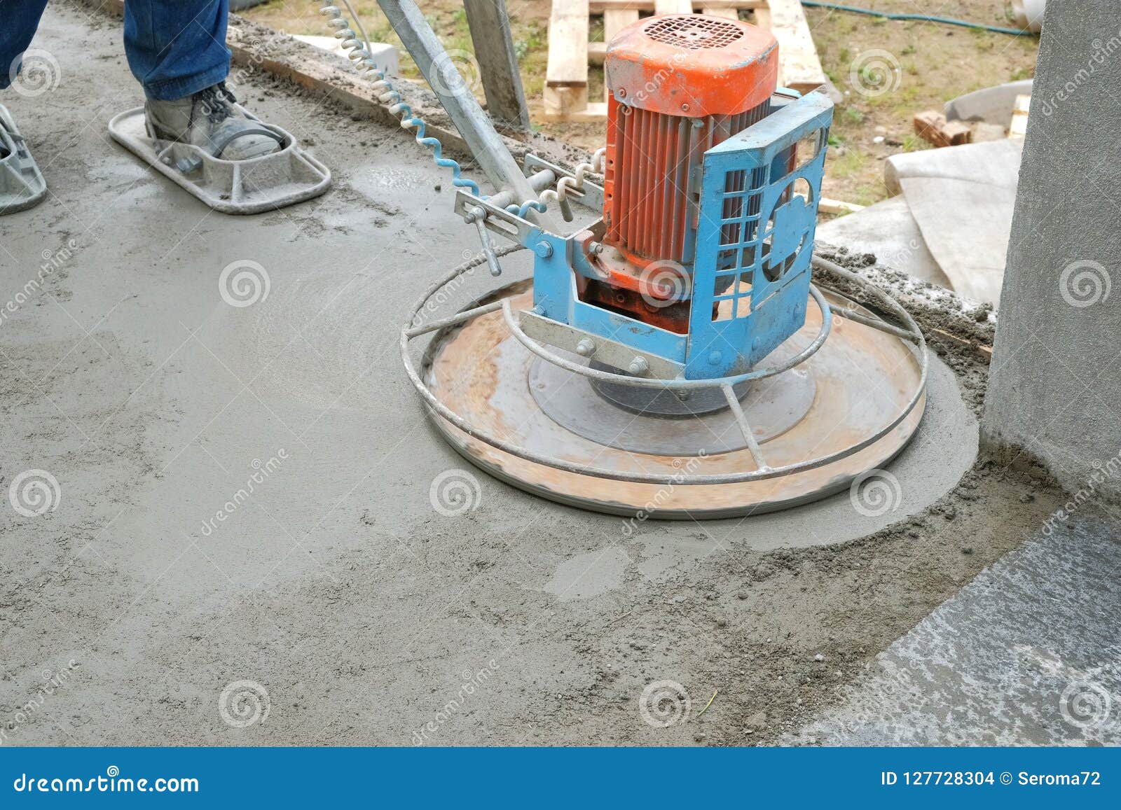 The Workers Grind the Concrete Floor at the Construction Site Stock ...