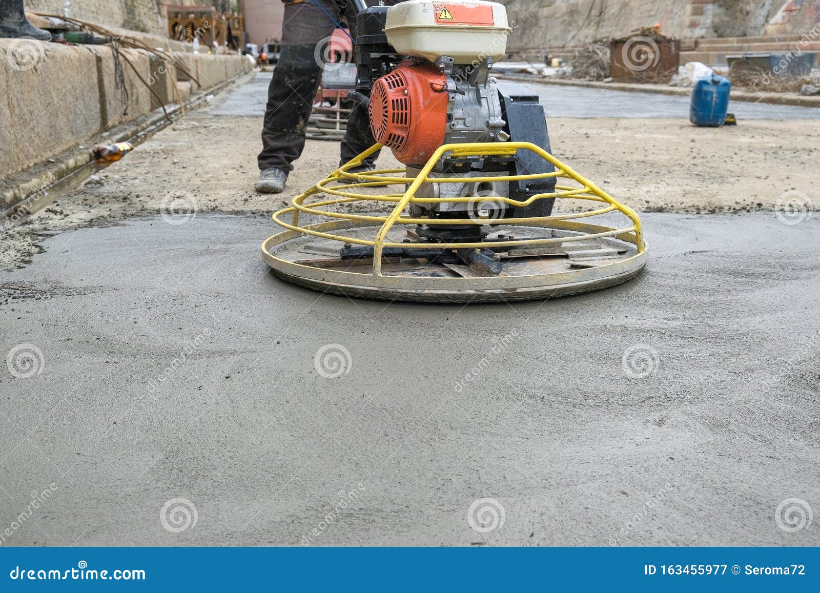 The Workers Grind the Concrete Floor at the Construction Site Stock ...