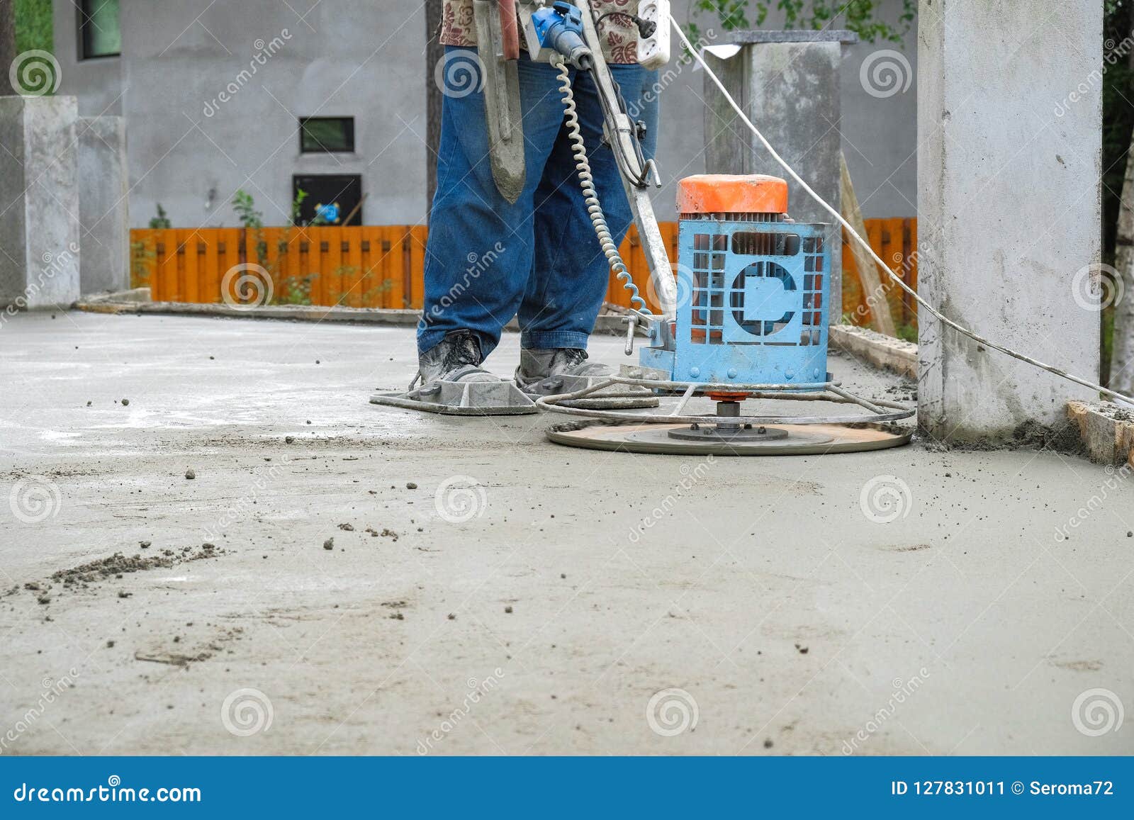 The Workers Grind the Concrete Floor at the Construction Site Stock ...