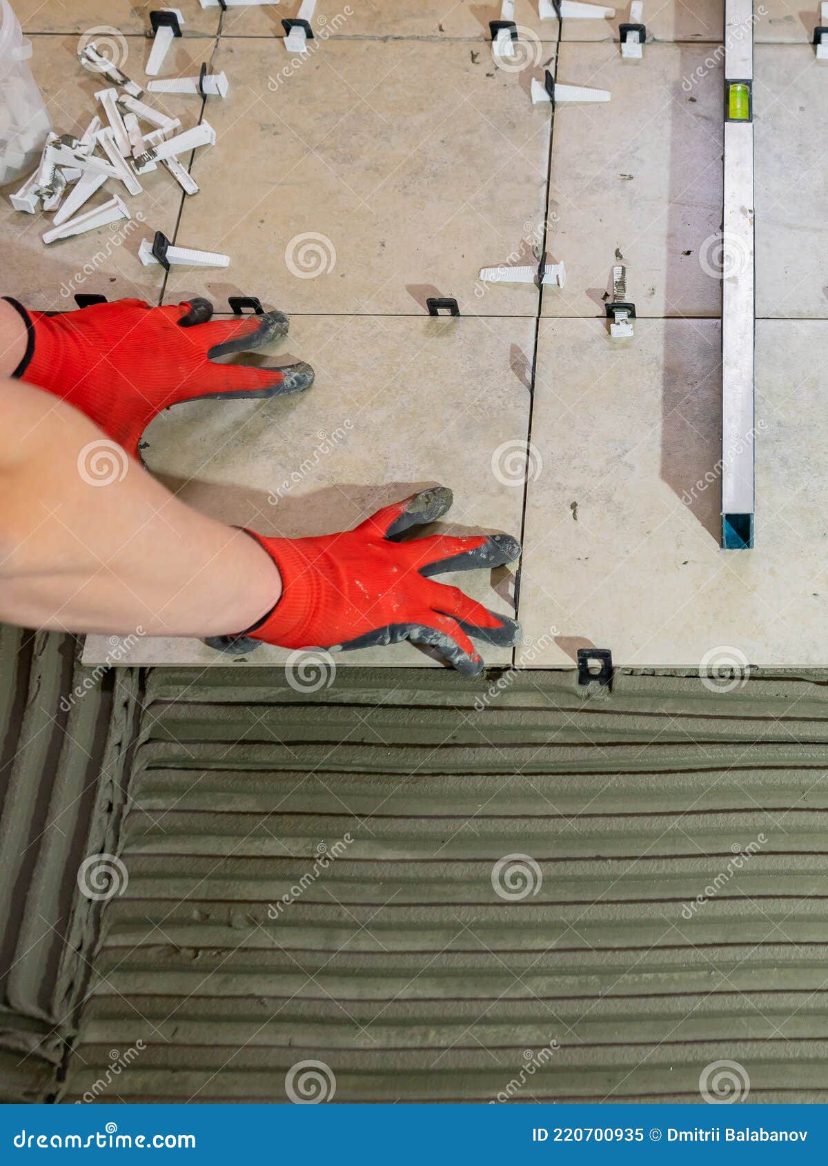 Workers Hands with Ceramic Tiles and Tools for Tiler. Floor Tiles ...