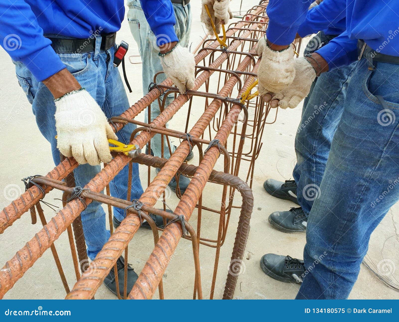 Workers Hands Using Steel Wire for Securing Steel Bars with Wire Rod ... Workers Hands Using Steel Wire for Securing Steel Bars with Wire Rod ...
