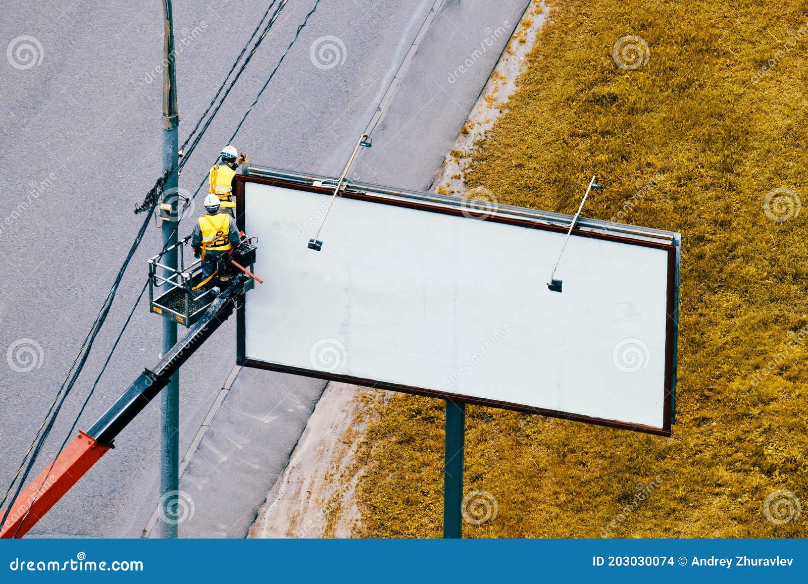 Workers Hang An Advertising Banner At A Height From The Ladders ...