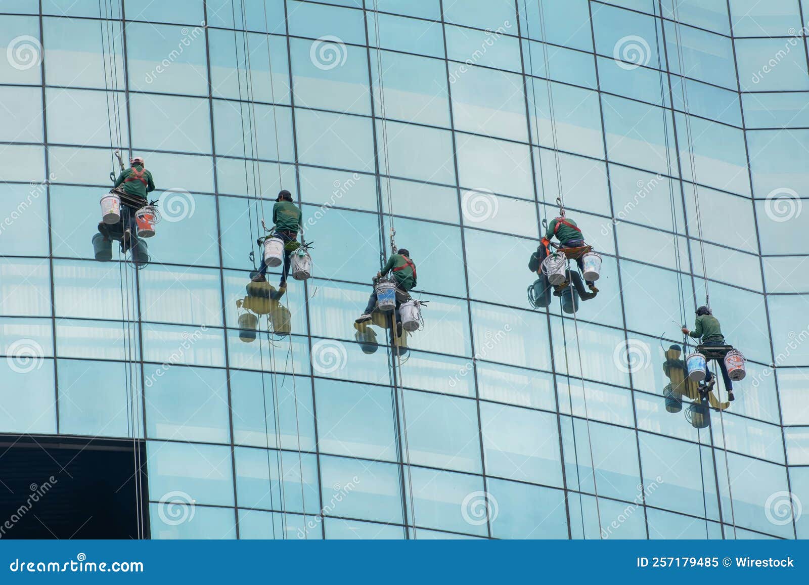 Workers Hanging Down while Cleaning the Glass Windows of the Skyscraper ...