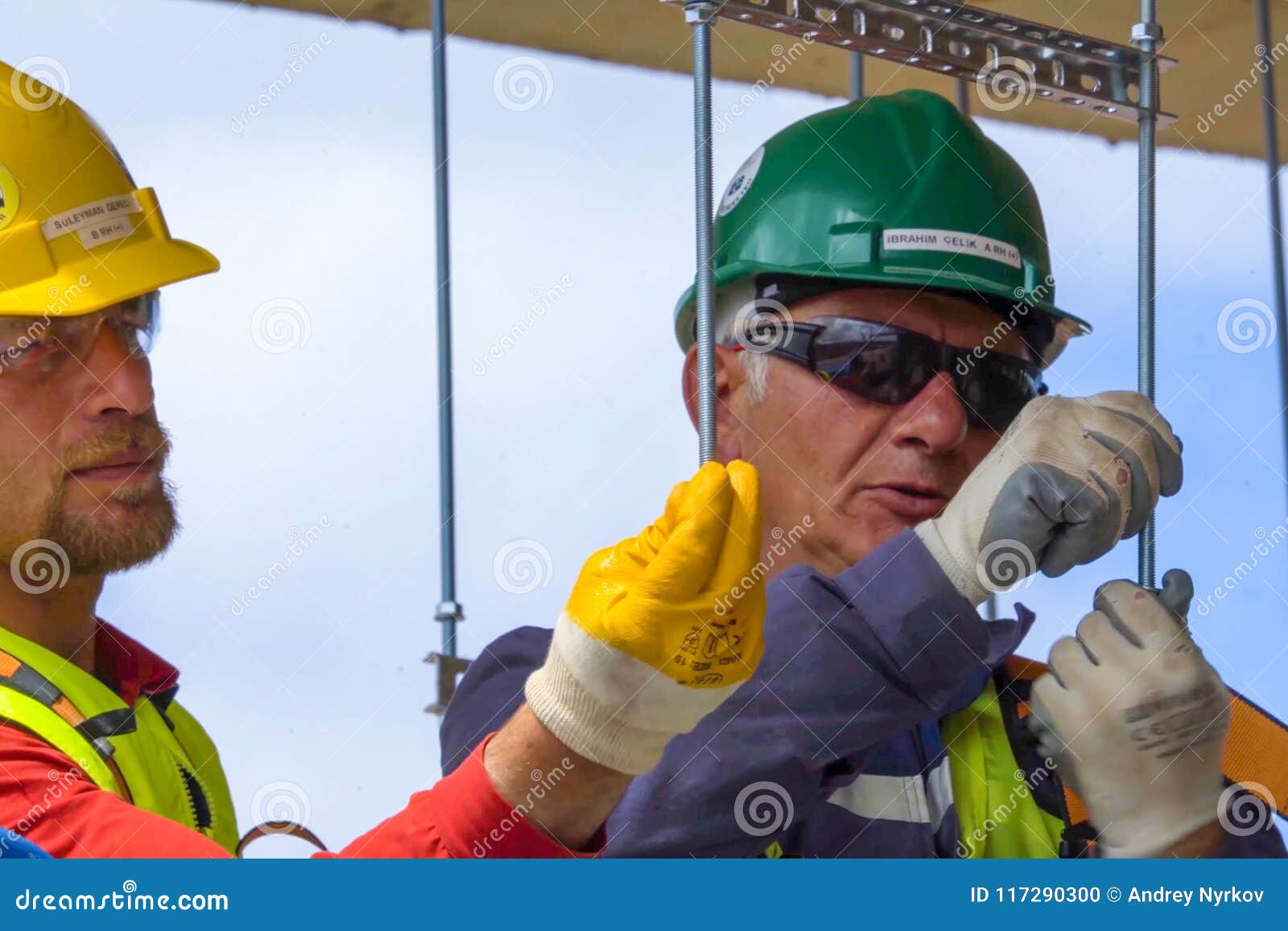 Workers in Helmets on the Construction Site. Construction Works ...