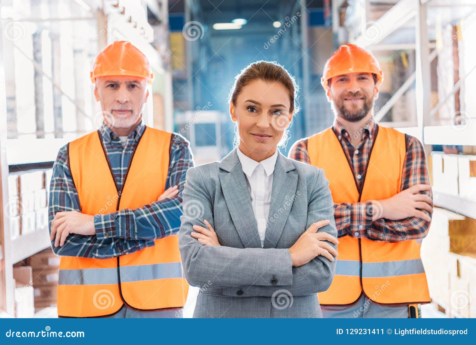 Workers in Helmets and Inspector in Suit Posing with Crossed Arms Stock ...